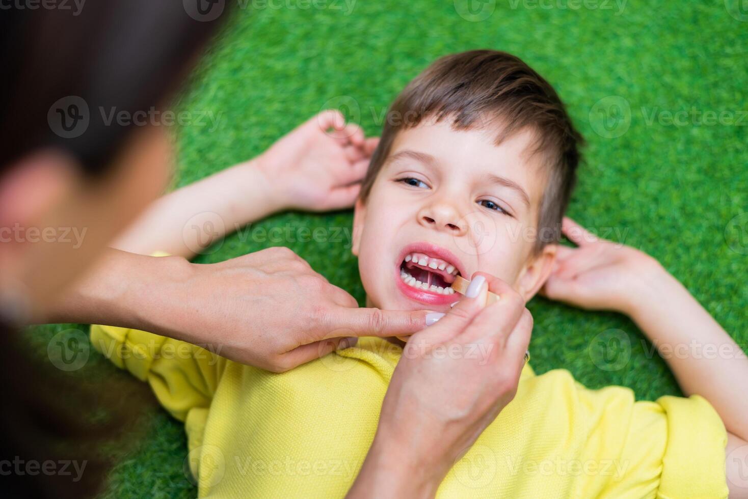 A little boy is engaged in a speech therapist's office and corrects his ... A little boy is engaged in a speech therapist's office and corrects his ...
