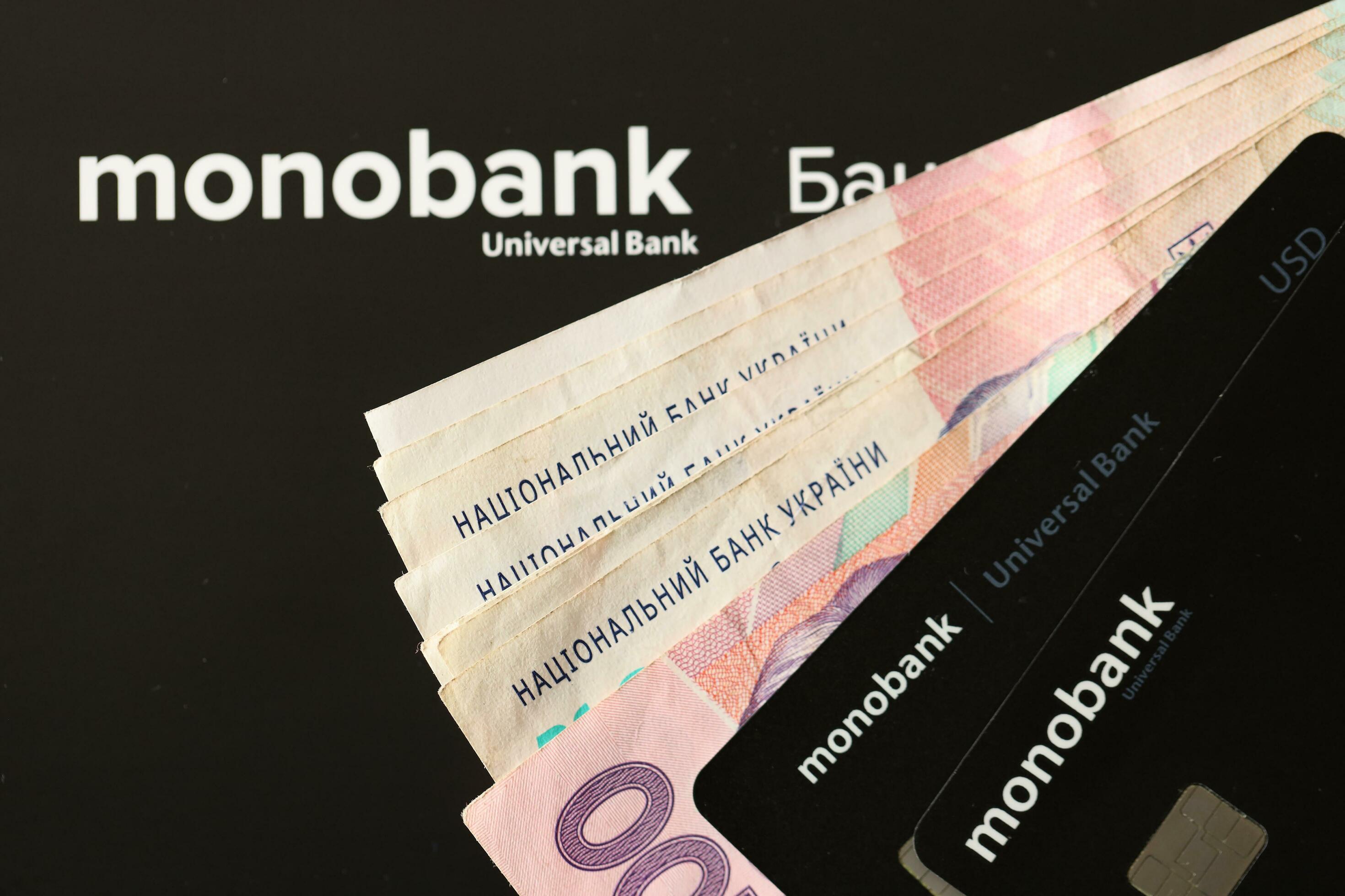 KYIV, UKRAINE - JULY 7, 2023 Monobank banking plastic cards with money on table 33652221 Stock ...