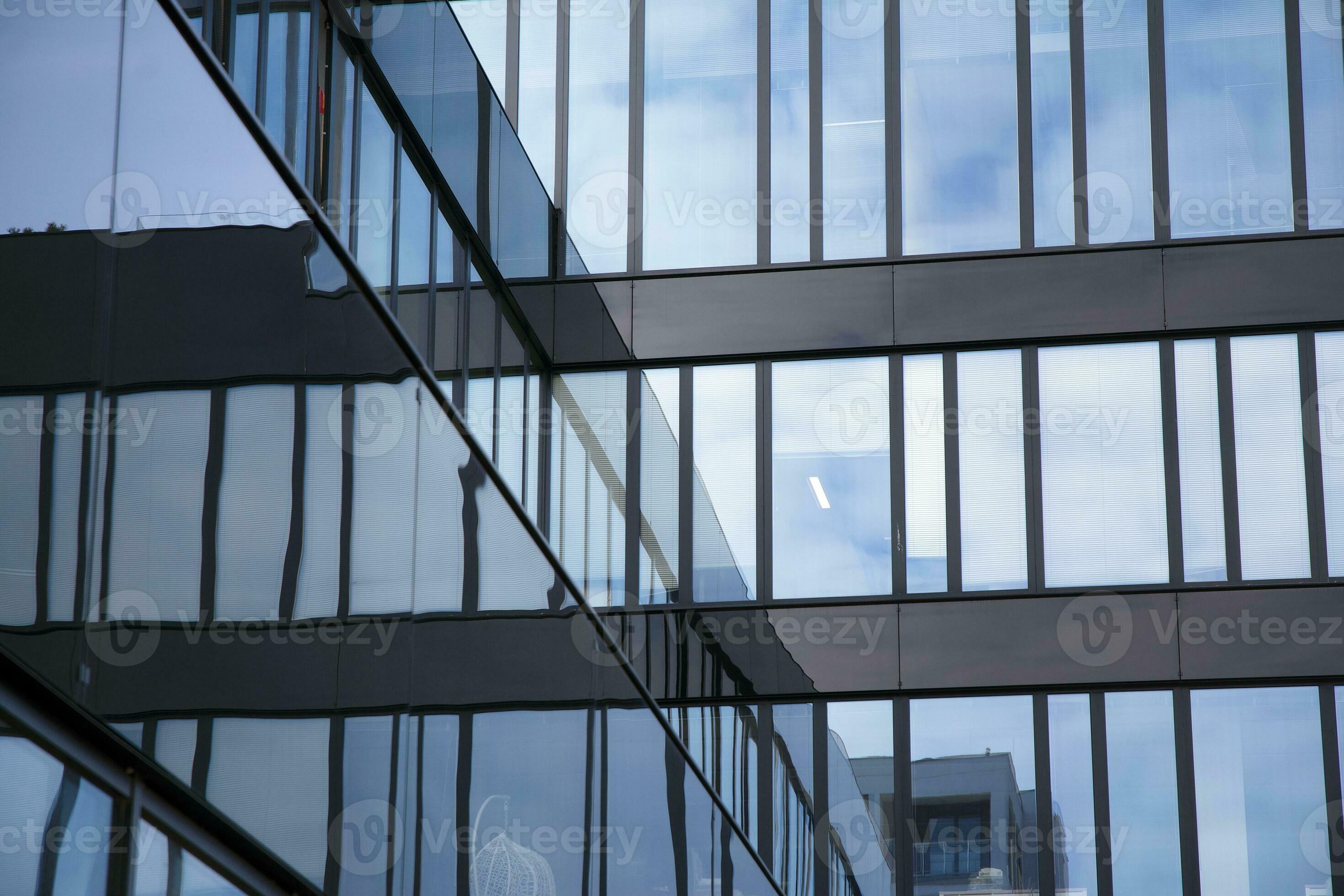Glass building with transparent facade of the building and blue sky. Structural glass wall ...