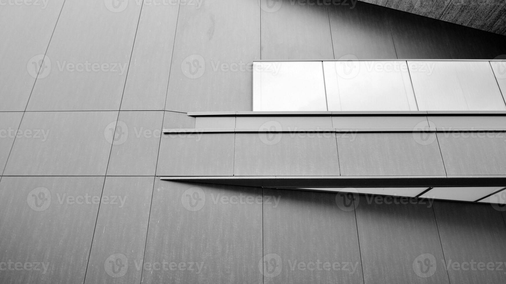 A view at a straight facade of a modern building with a dark grey ... A view at a straight facade of a modern building with a dark grey ...