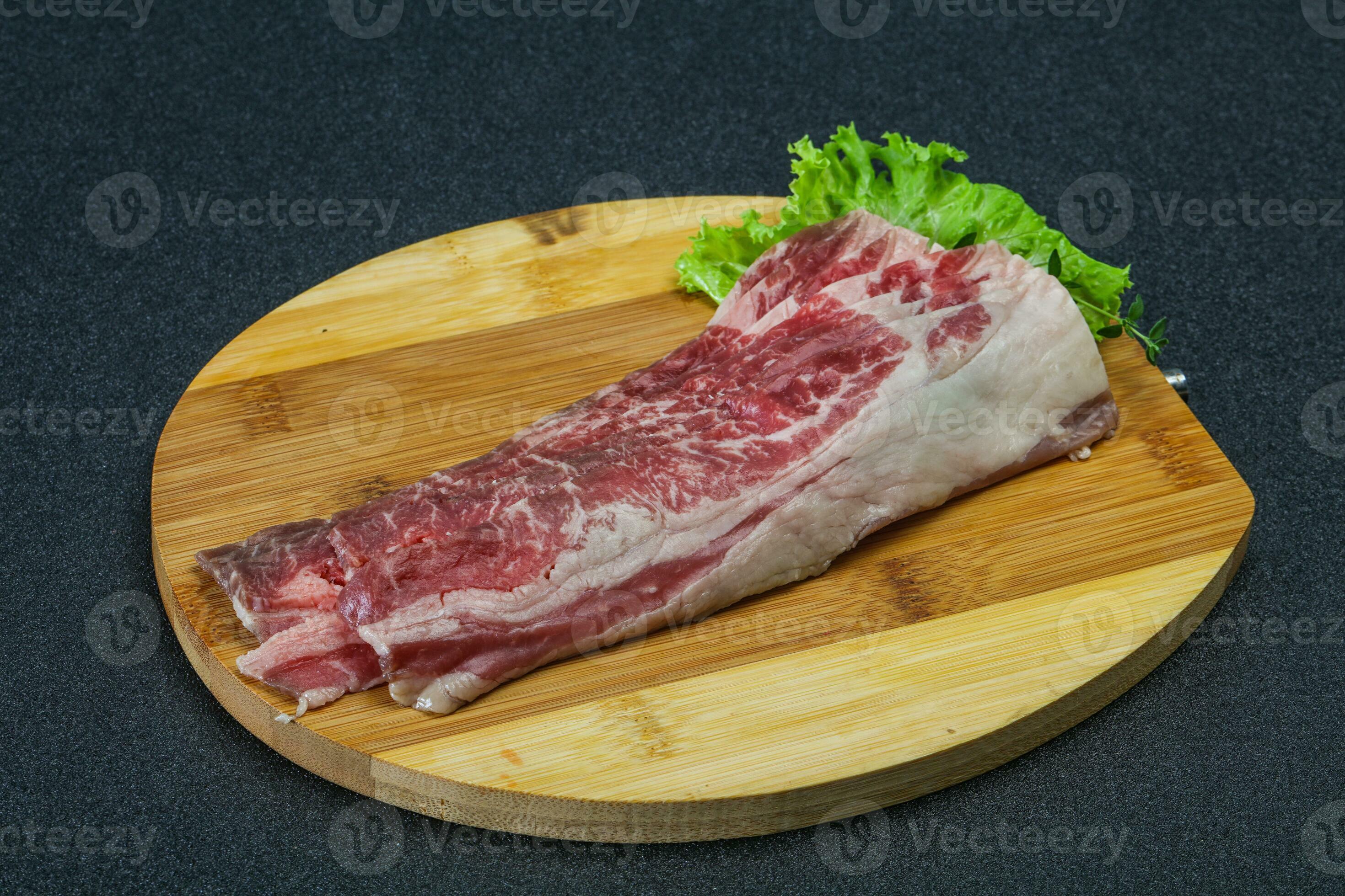 Raw beef bacon over wooden board 34071391 Stock Photo at Vecteezy