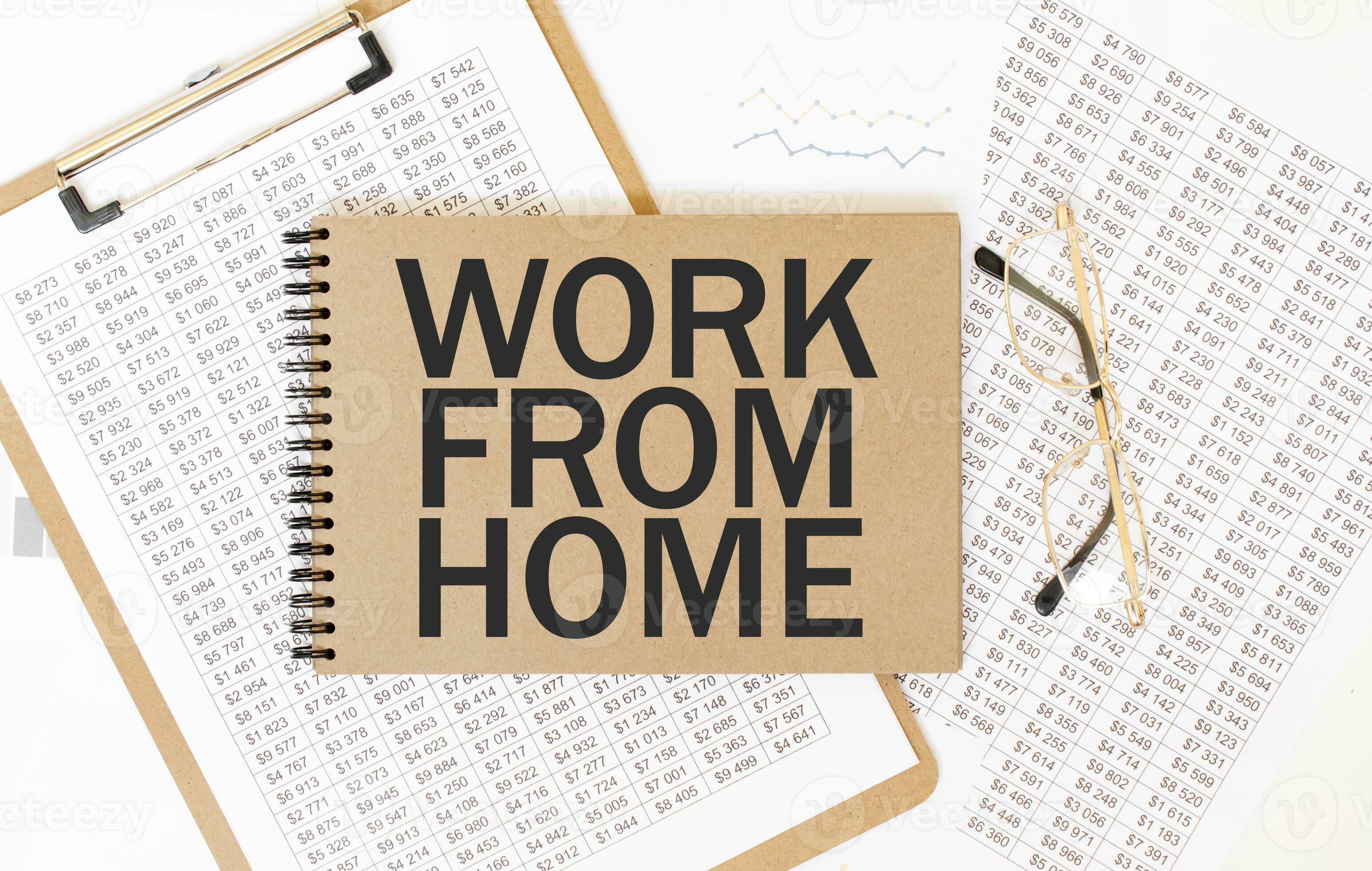 Craft colour notepad with text WORK FROM HOME. Notepad with eyeglasses and text documents ...