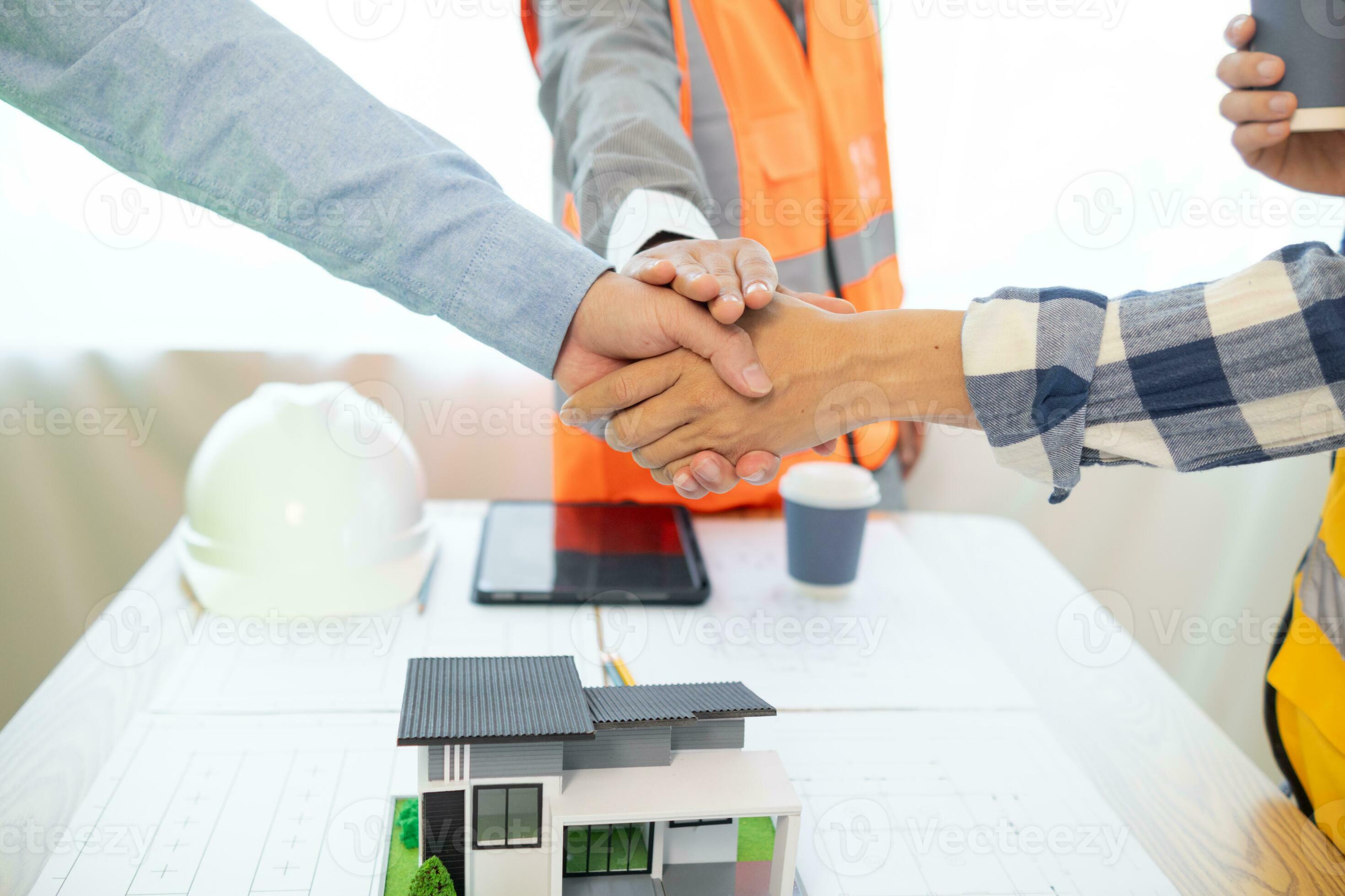 Architects and construction engineering handshake after meeting discuss ...