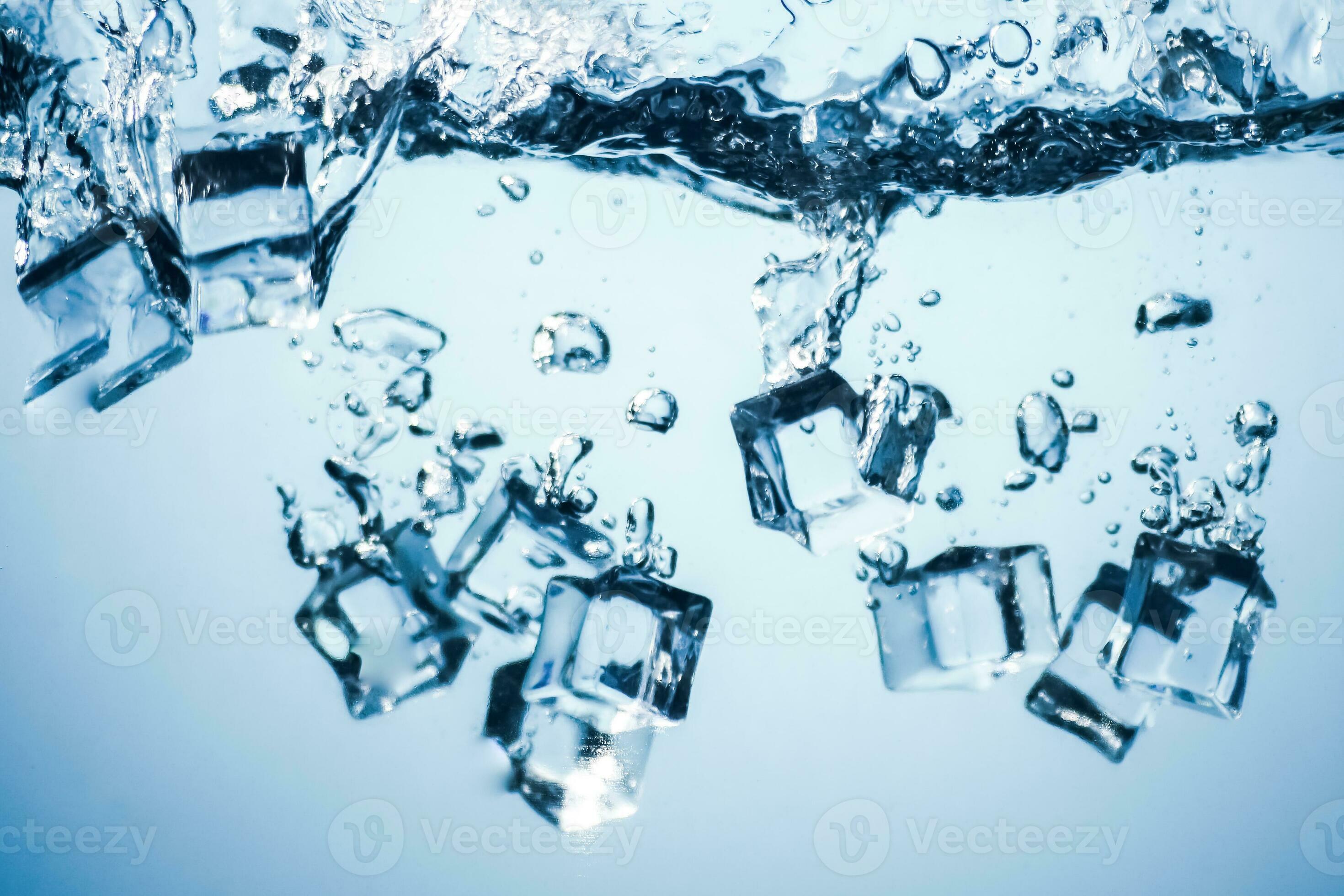 ice cubes falling down. ice cubes on blue background. splash on blue. ice cubes in water ...
