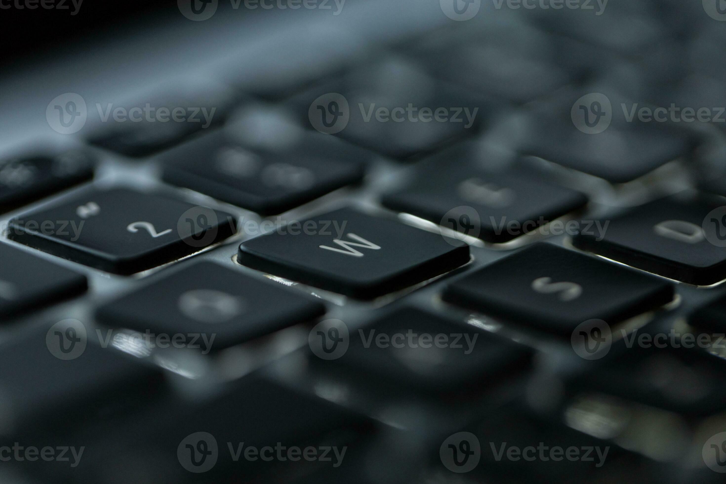 Modern backlit laptop keyboard with button W, close-up. Concept ...