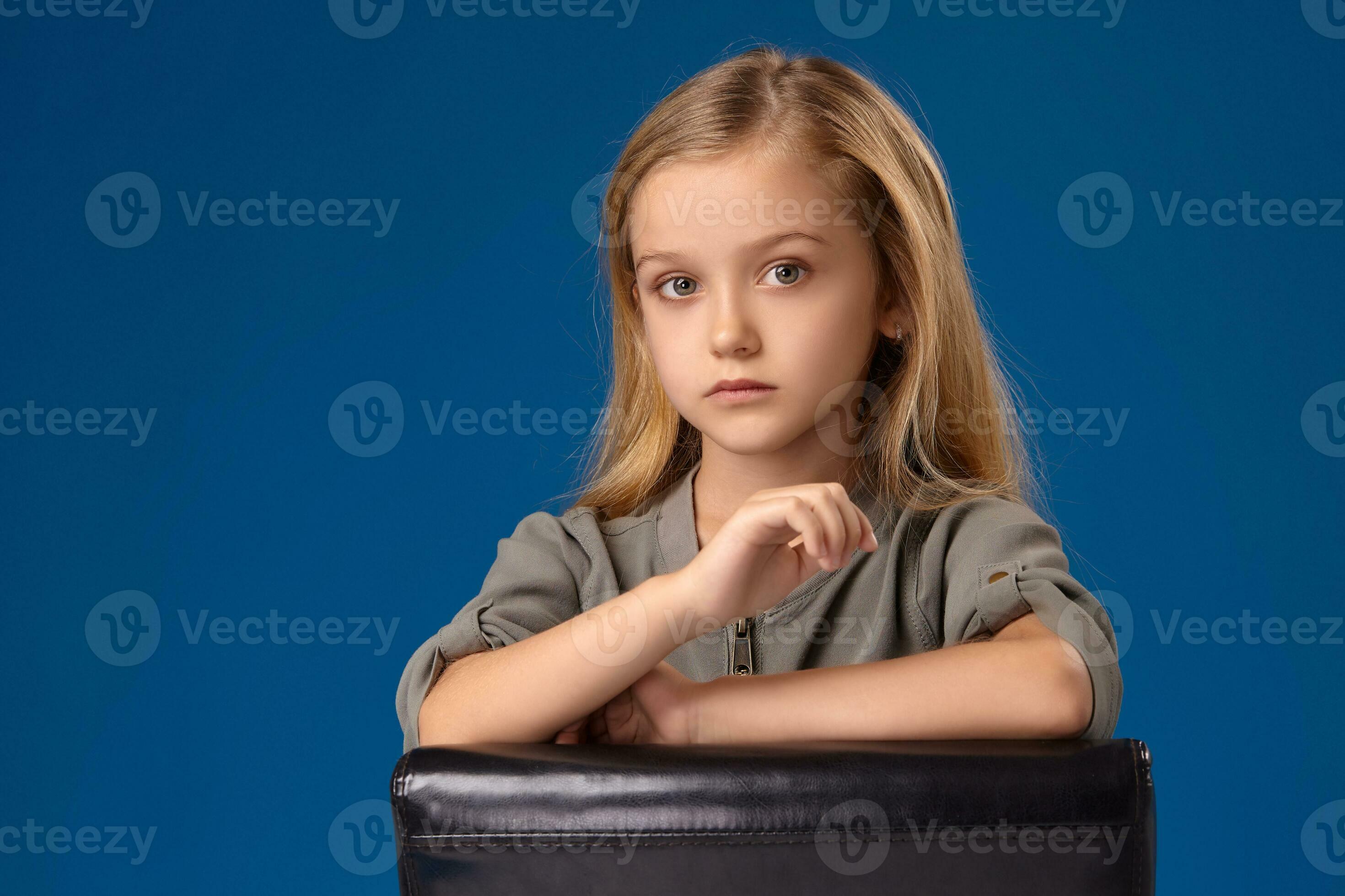 Little girl with gray eyes and blond hair sits on a chair 34919438 ...