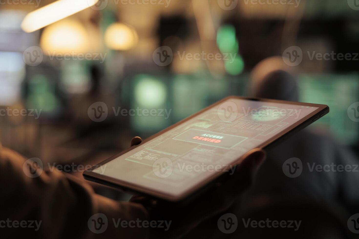 Cybercriminal looking at failed hacking method on tablet, using professional malware and ...