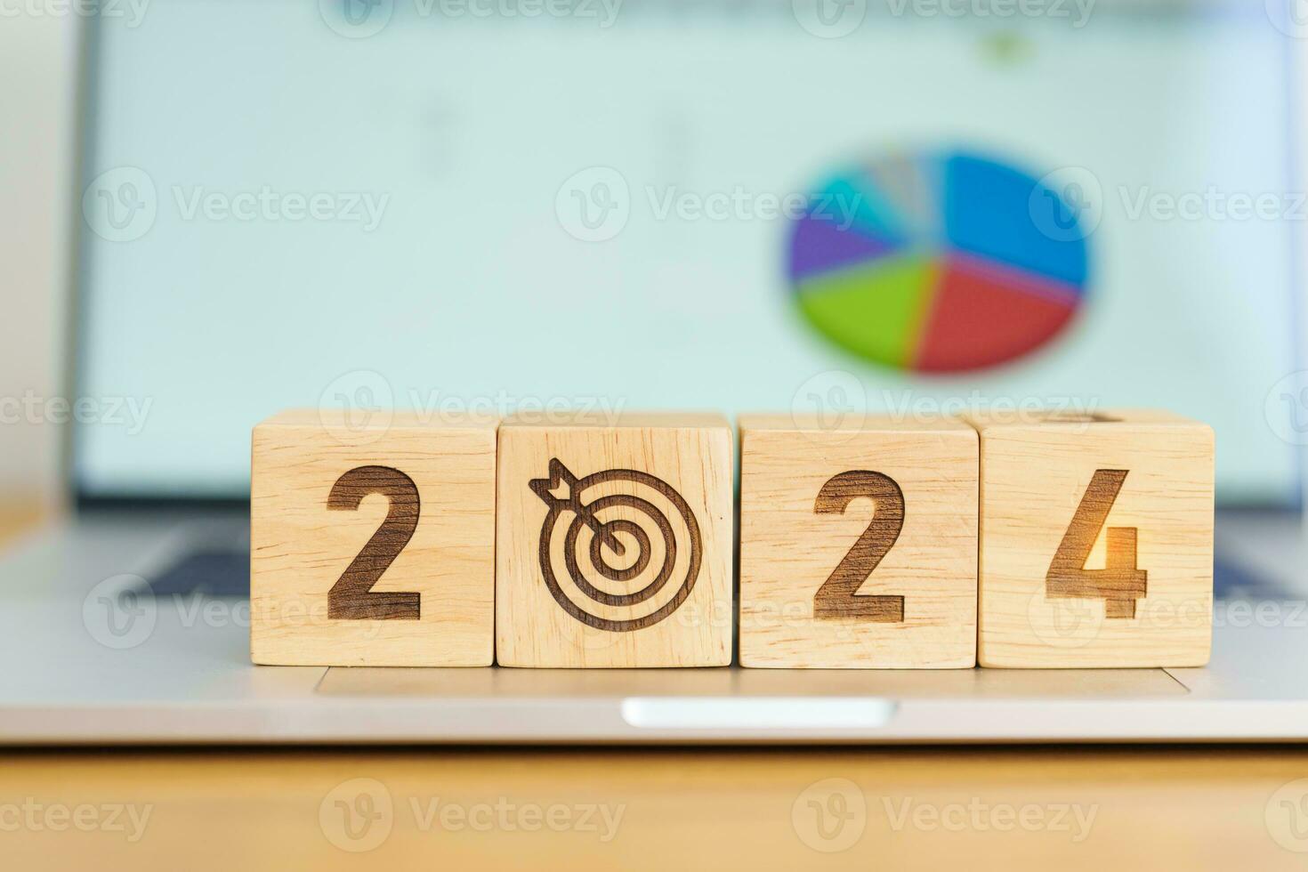 2024 Year block with dartboard icon against computer laptop background. Goal, Target, Resolution ...