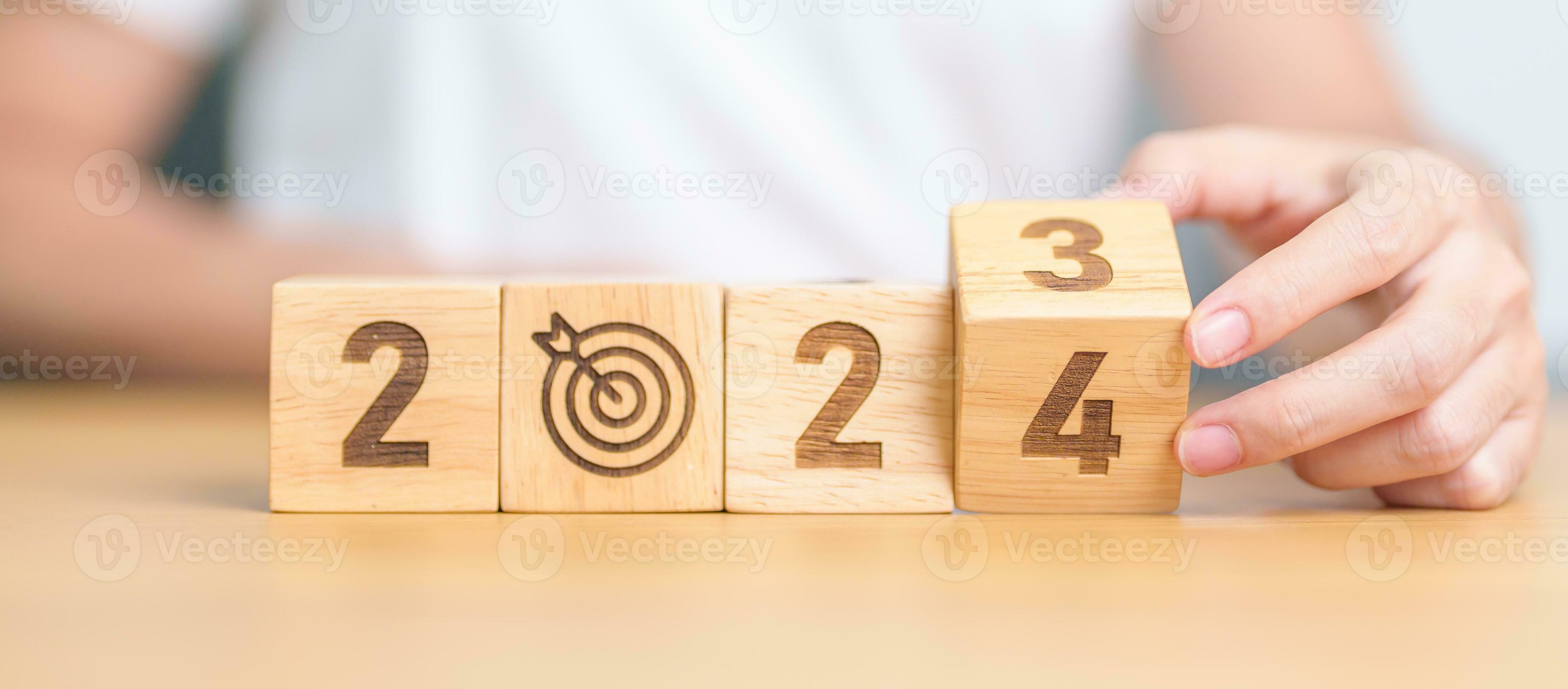 2023 year change to 2024 year block with dartboard icon. Goal, Target, Resolution, strategy ...