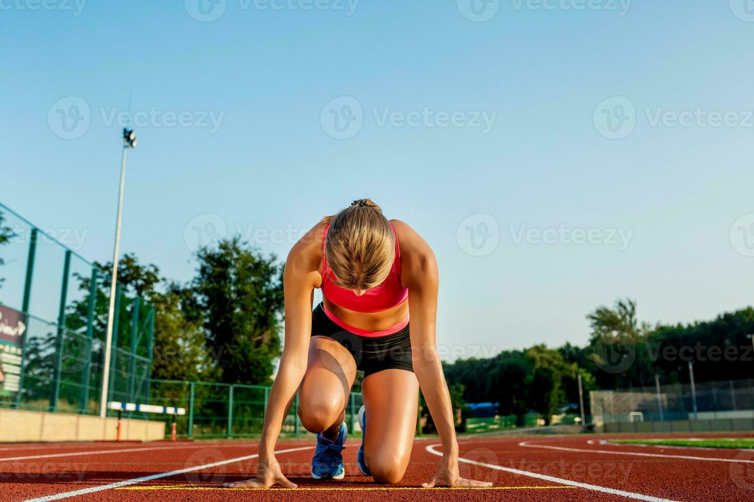 Young Woman Athlete At Starting Position Ready To Start A Race On