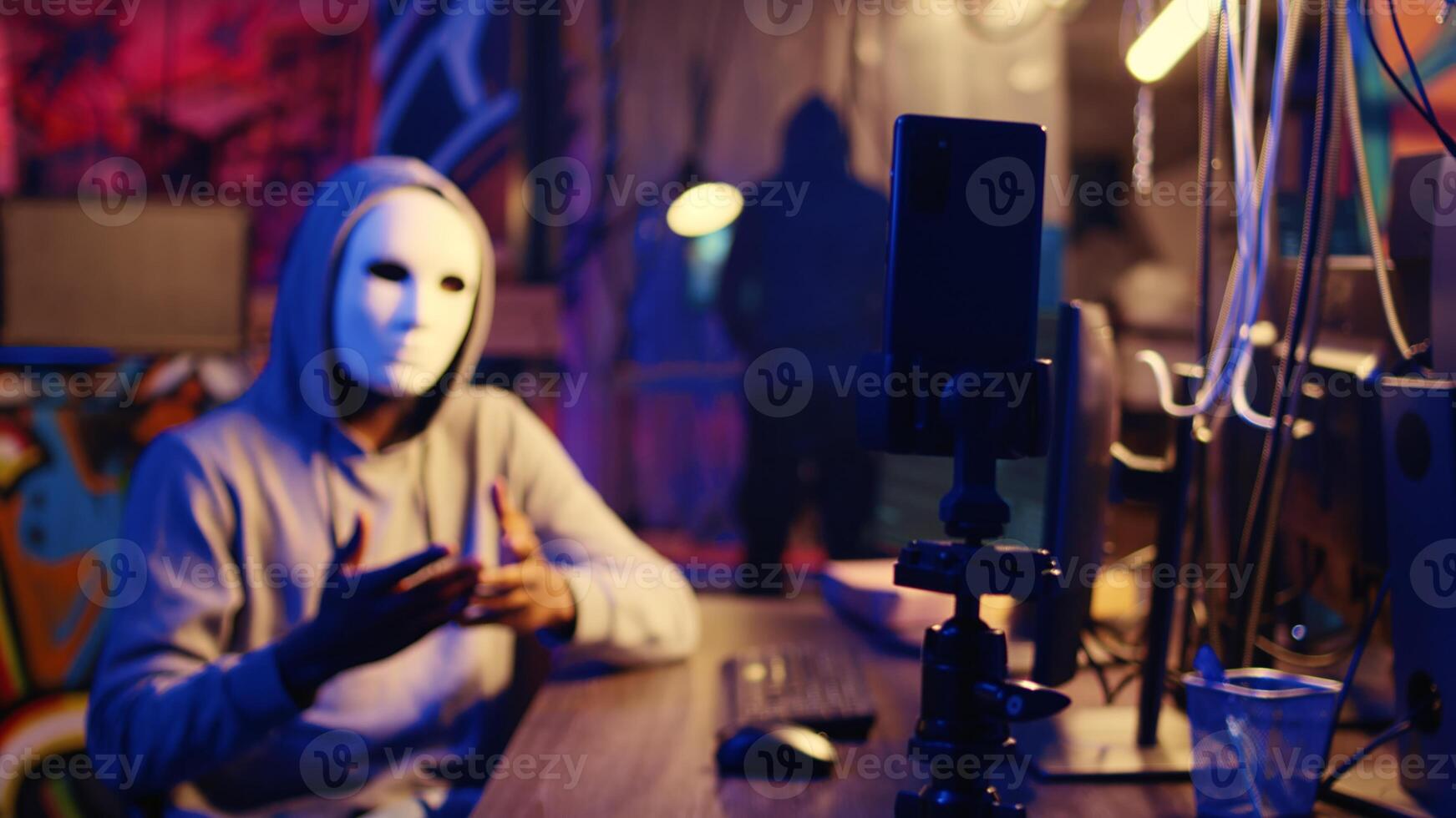 Hacker Wearing Anonymous Mask Threatens Victim With Deploying Malware Designed To Exploit