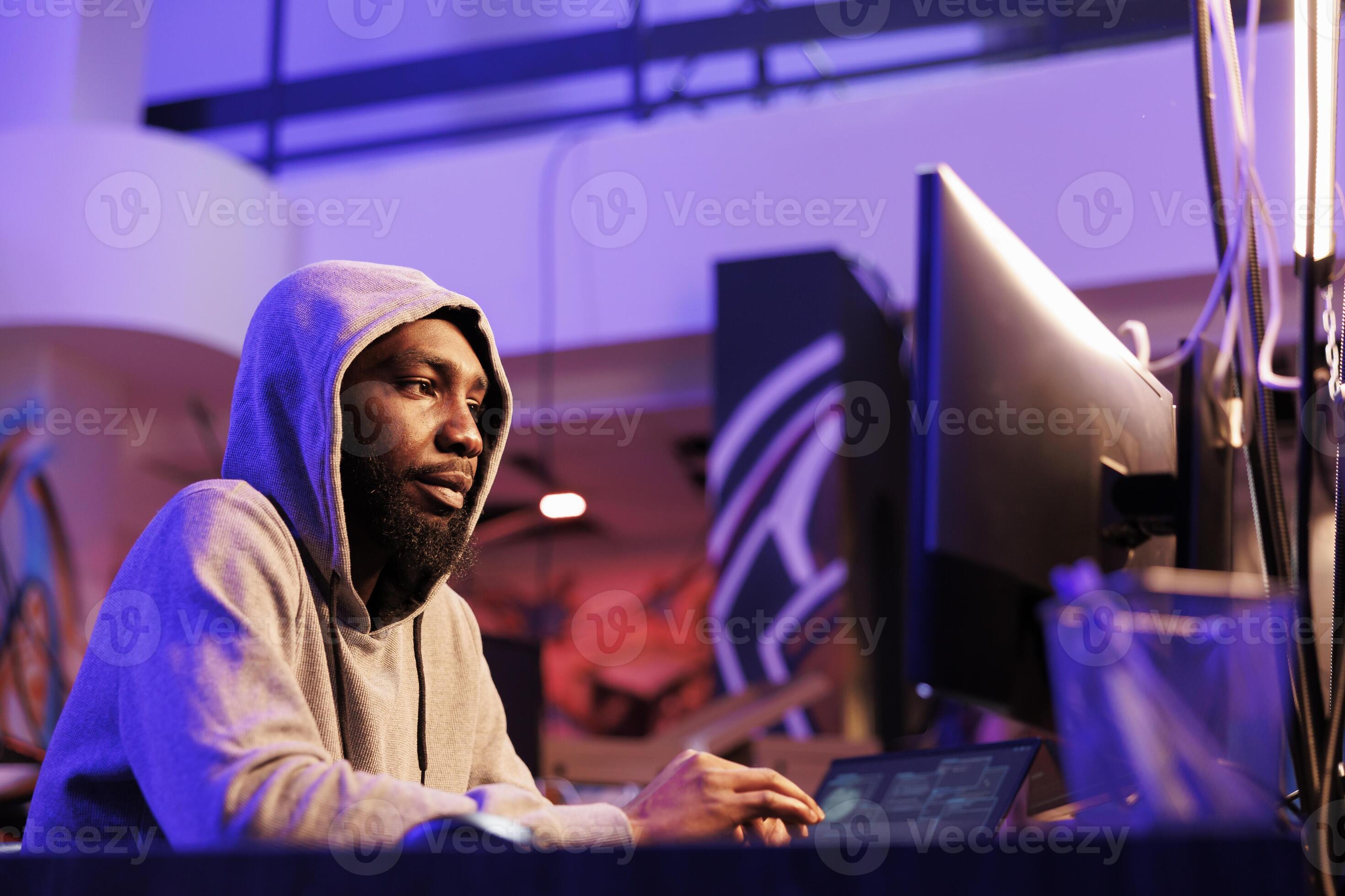 African american criminal hacking online server and stealing information. Hacker in hood ...