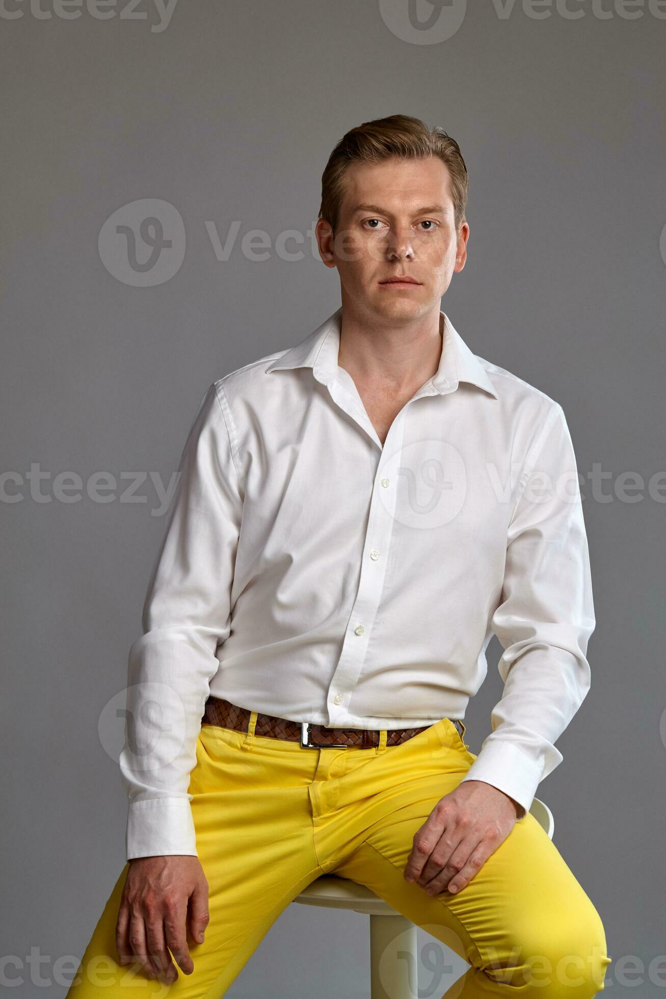 Close-up portrait of a ginger guy in white shirt posing on gray ...