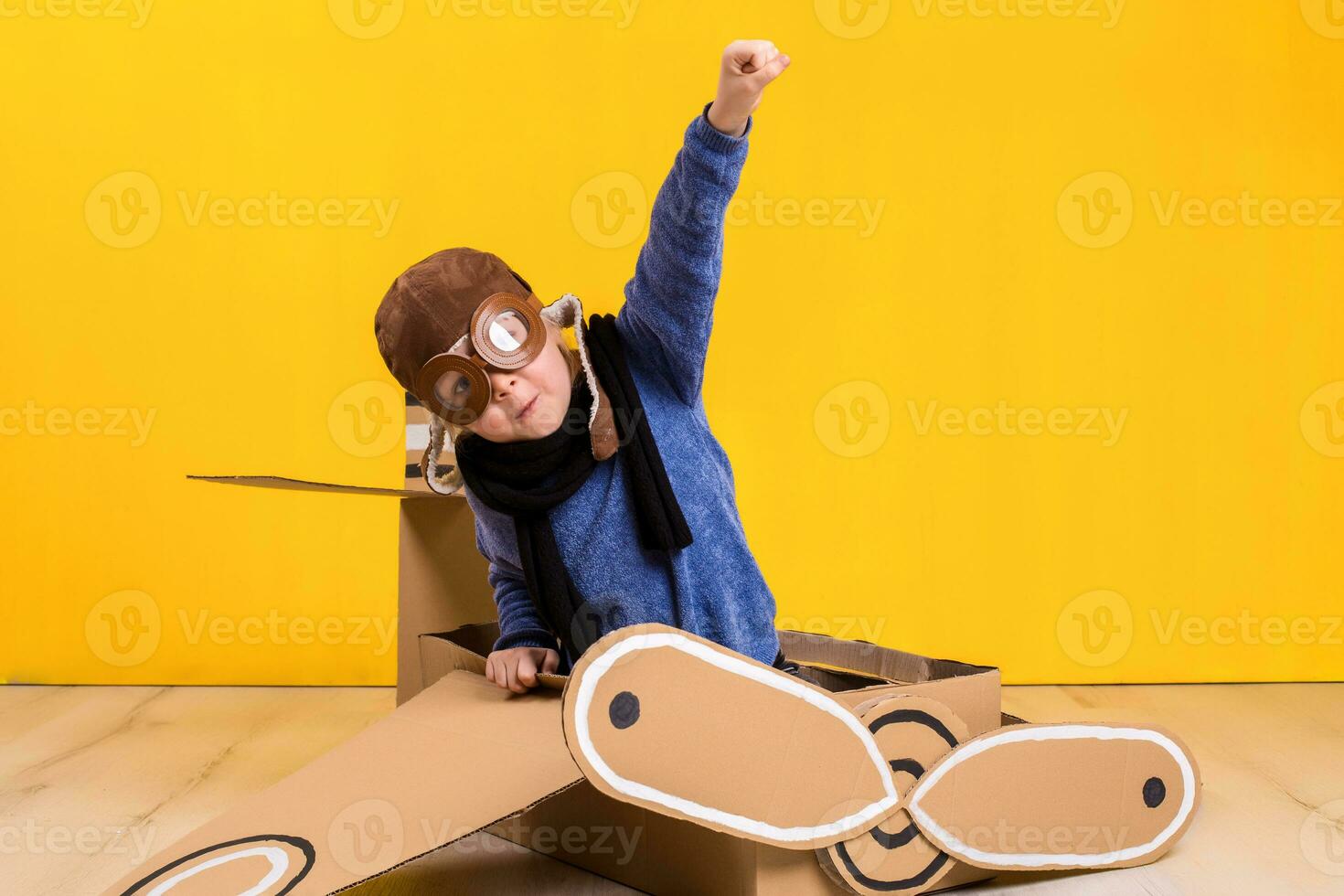 Little dreamer girl playing with a cardboard airplane. Childhood ...