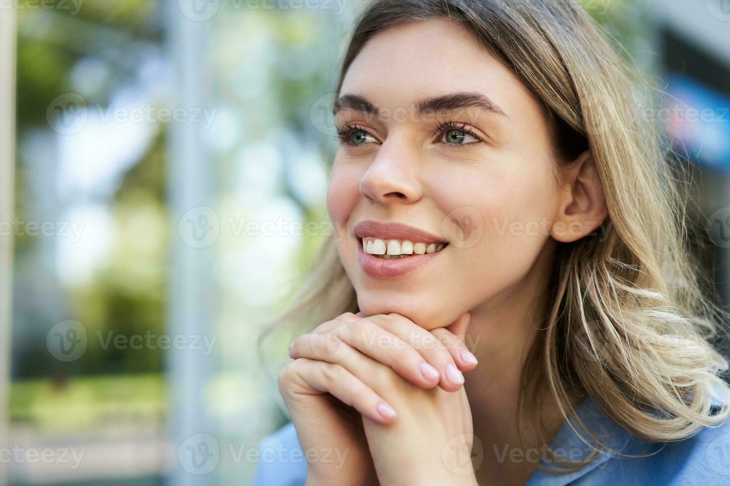 Close up portrait of young woman, looking hopeful and smiling, lean ...