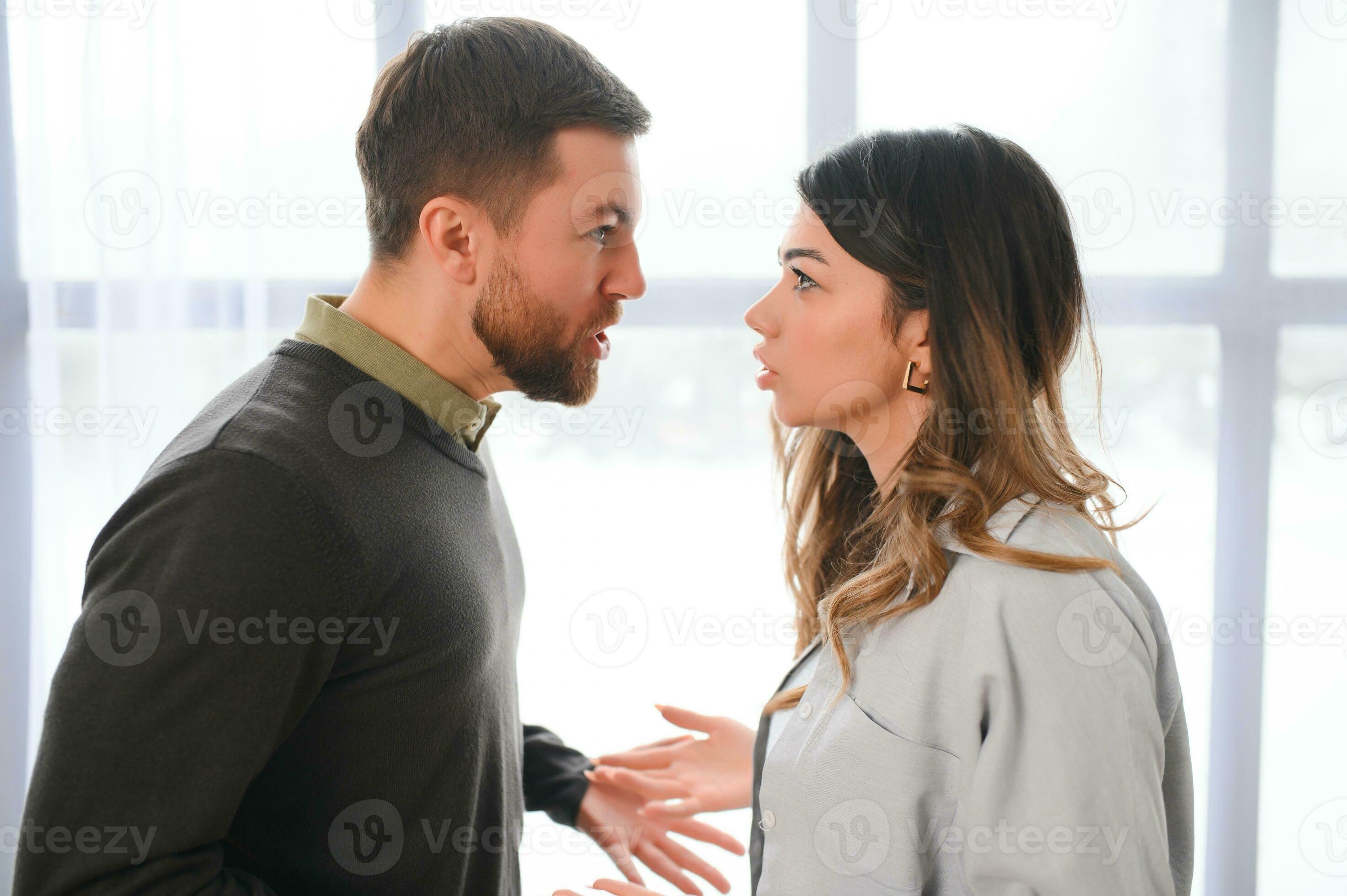 Boyfriend and girlfriend are arguing at home. Angry man is yelling at ...