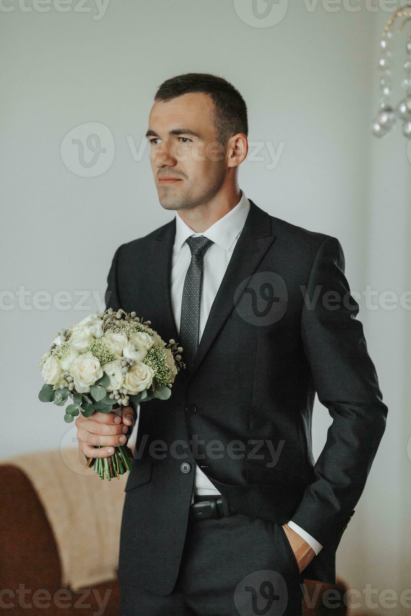 Portrait. A man in a white shirt, black bow tie and black tie poses in ...