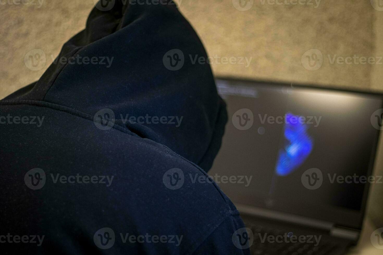 Man Looked Like Hacker In A Hood Sitting In The Front Of Laptop