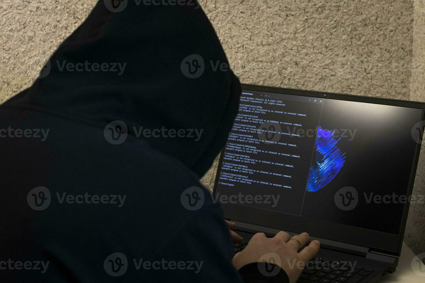 Man Looked Like Hacker In A Hood Sitting In The Front Of Laptop