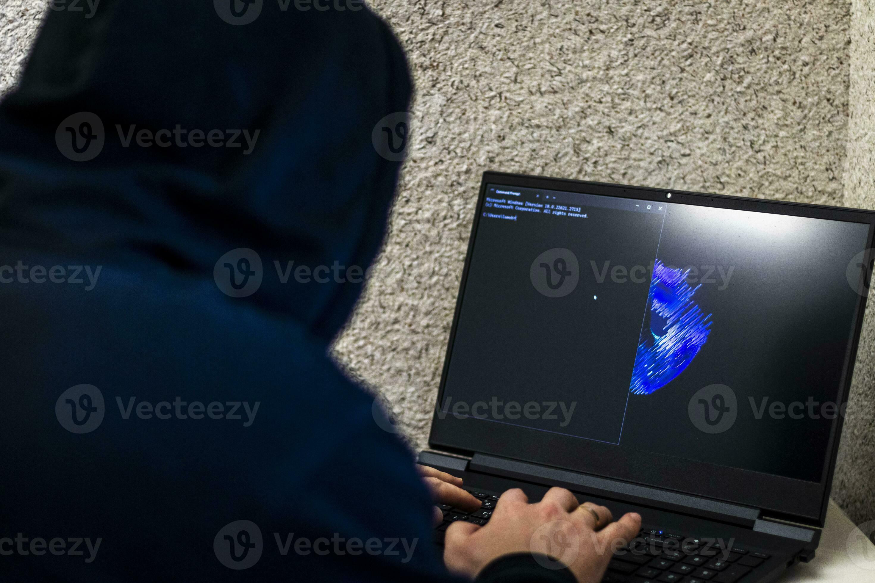 Man Looked Like Hacker In A Hood Sitting In The Front Of Laptop