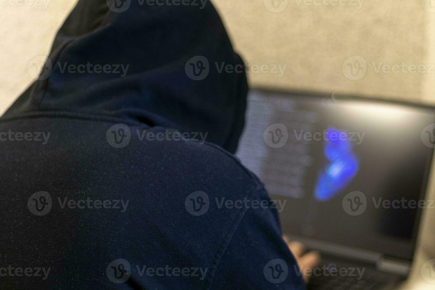 Man Looked Like Hacker In A Hood Sitting In The Front Of Laptop