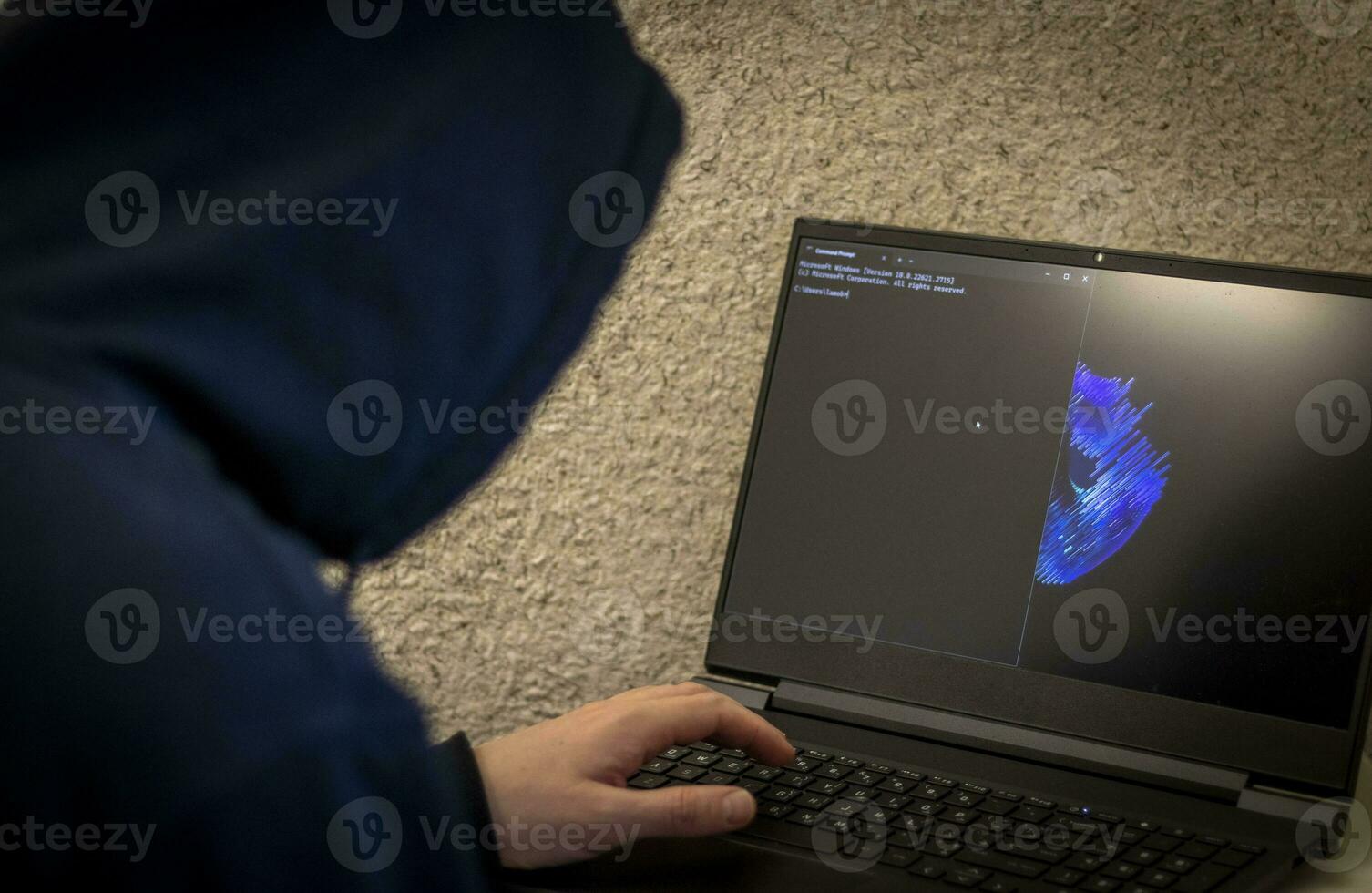 Man Looked Like Hacker In A Hood Sitting In The Front Of Laptop