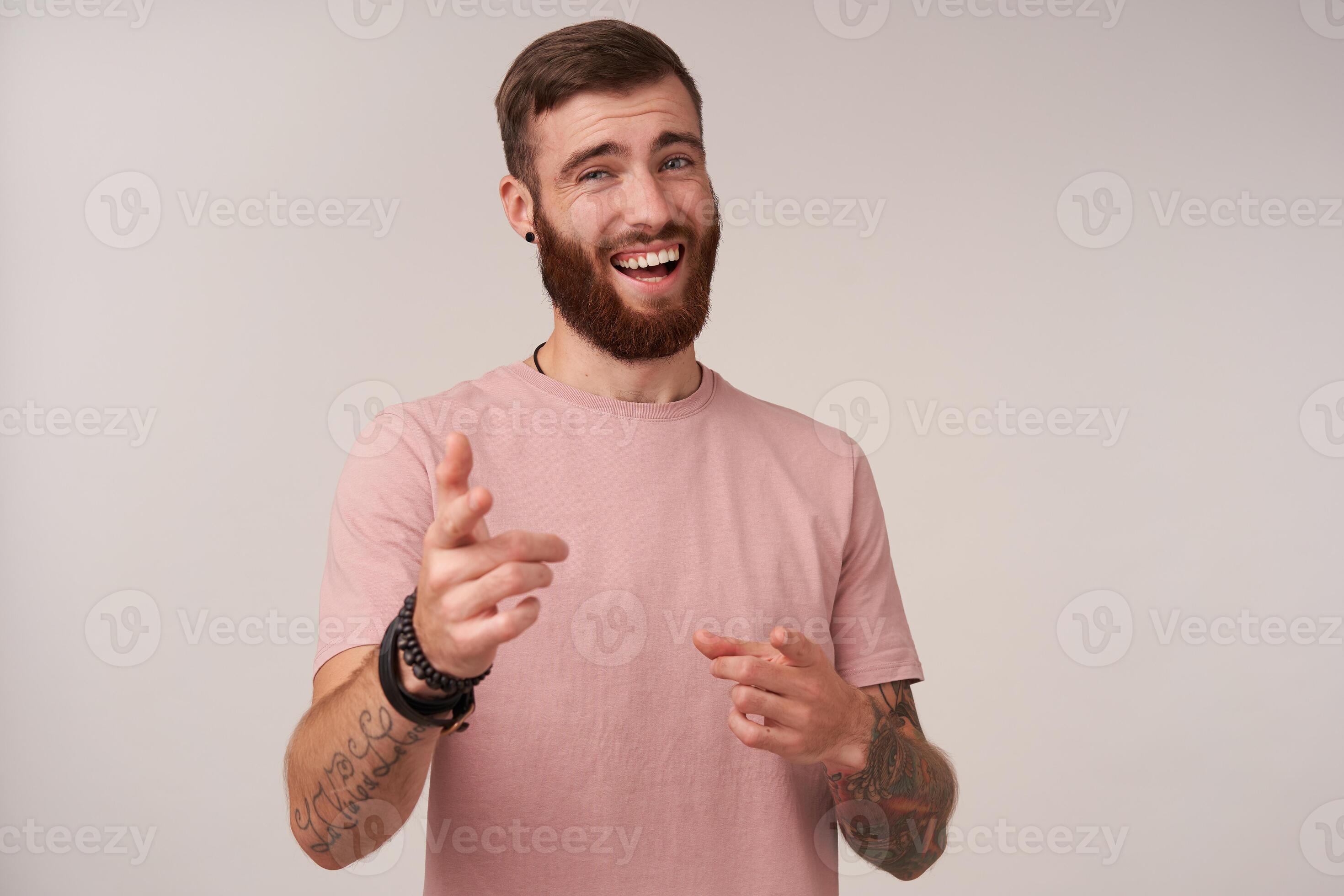 Cheerful young attractive bearded brunette man with trendy haircut ...