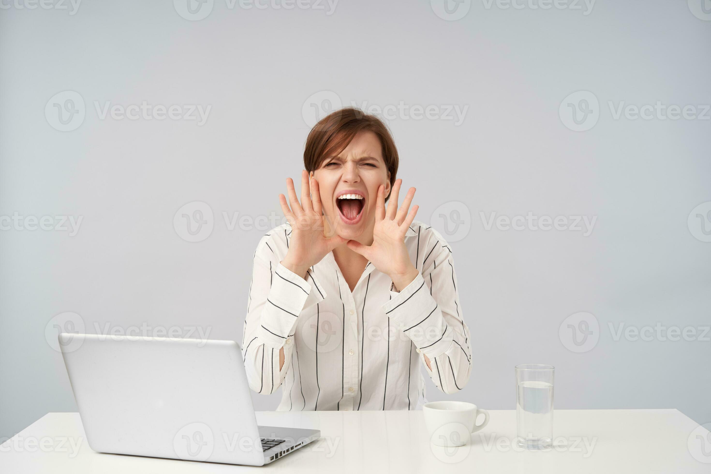 Excited young attractive short haired brunette lady raising hands to ... Excited young attractive short haired brunette lady raising hands to ...