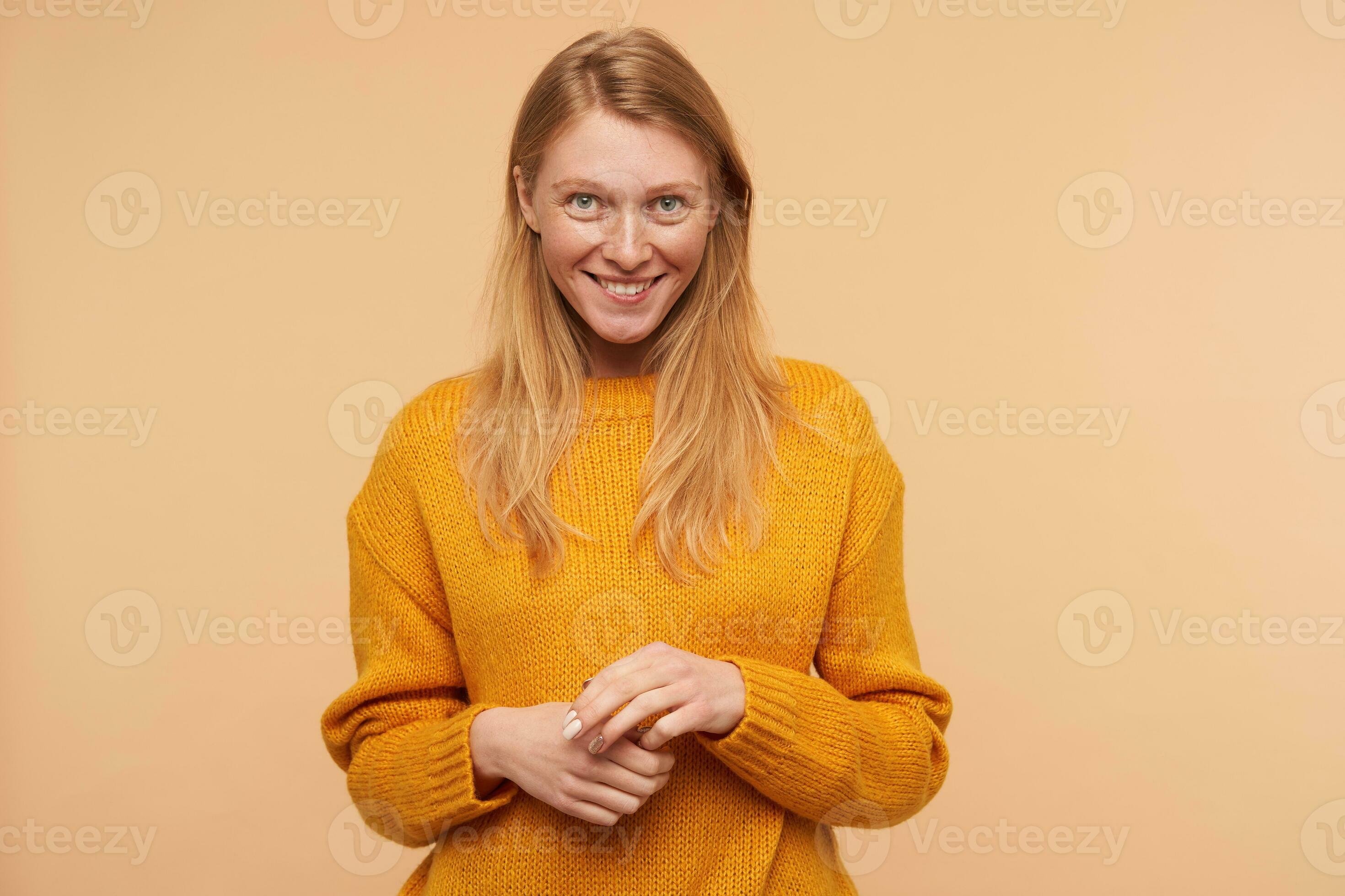 Indoor Photo Of Young Attractive Positive Long Haired Redhead Lady Smiling Pleasantly While