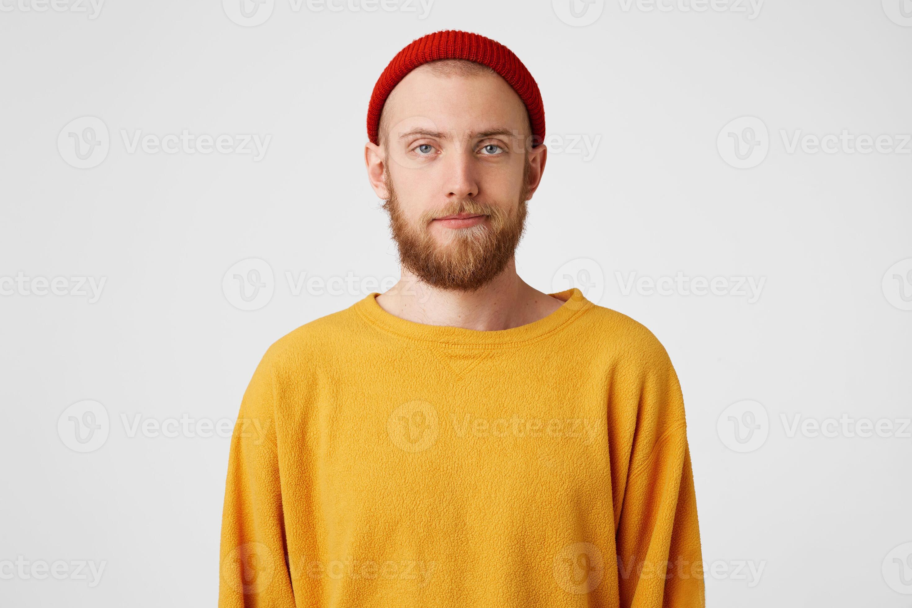 A young handsome guy with a beard,blue eyes, is standing with an ...