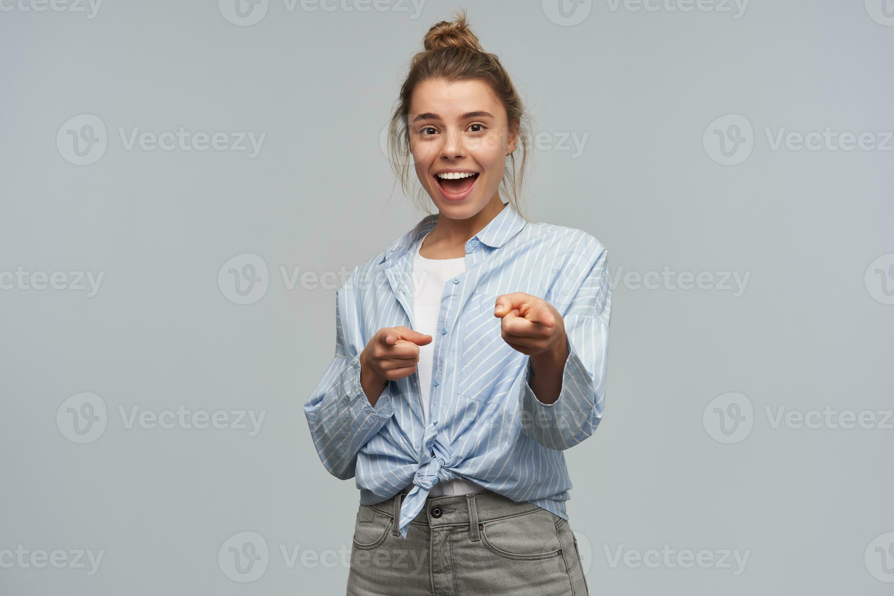 Portrait Of Attractive Adult Girl With Blond Hair Bun Wearing Blue
