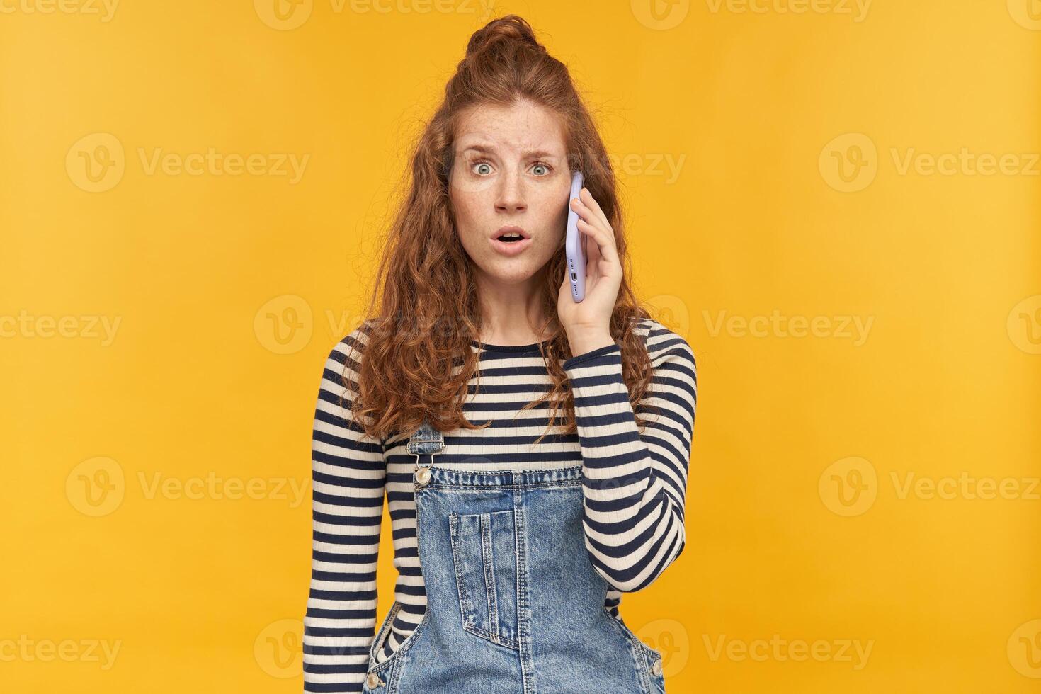 indoor studio shot of young ginger female with long red curly hair ...