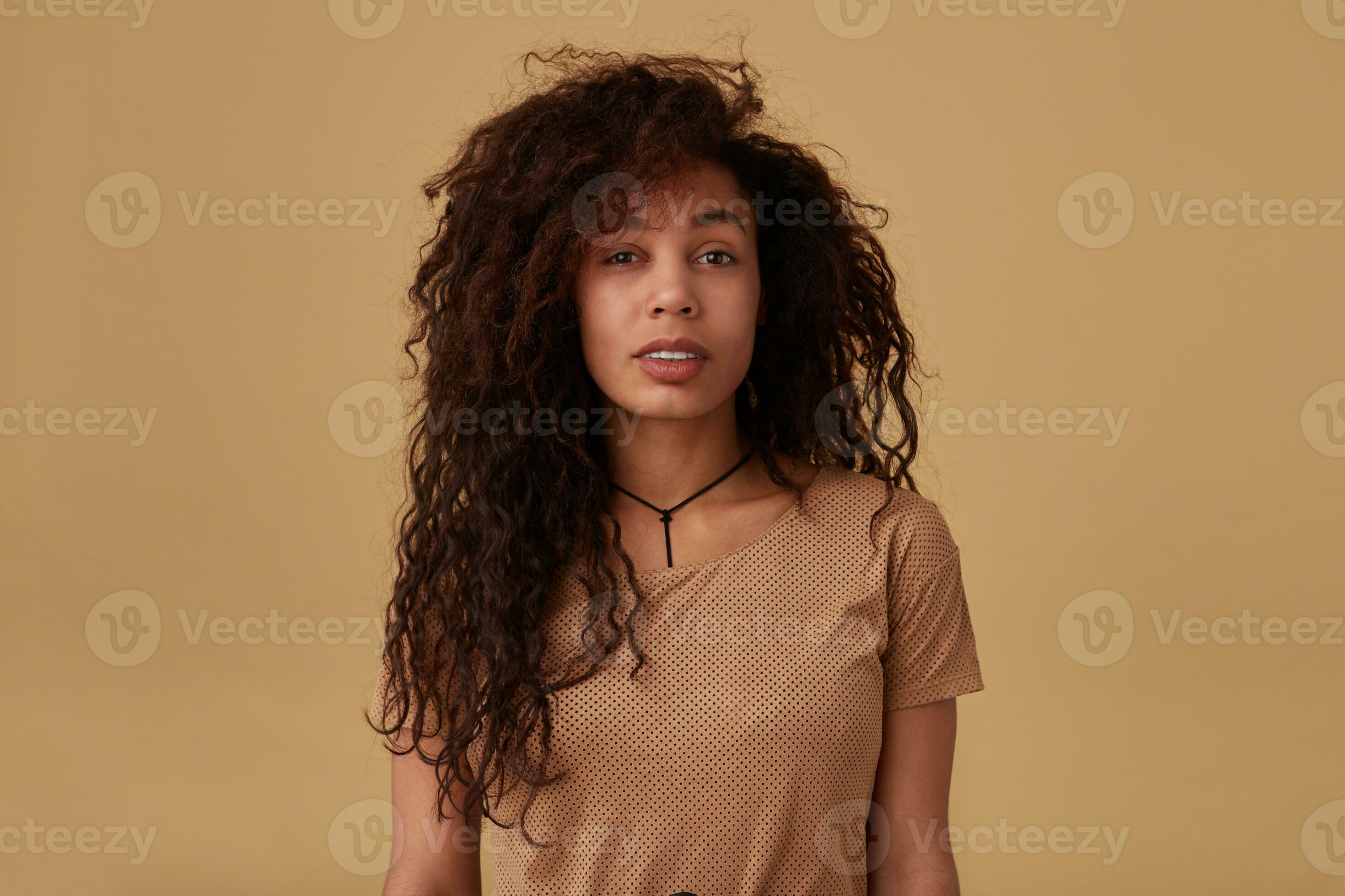 Portrait Of Young Long Haired Curly Dark Skinned Female With Voluminous