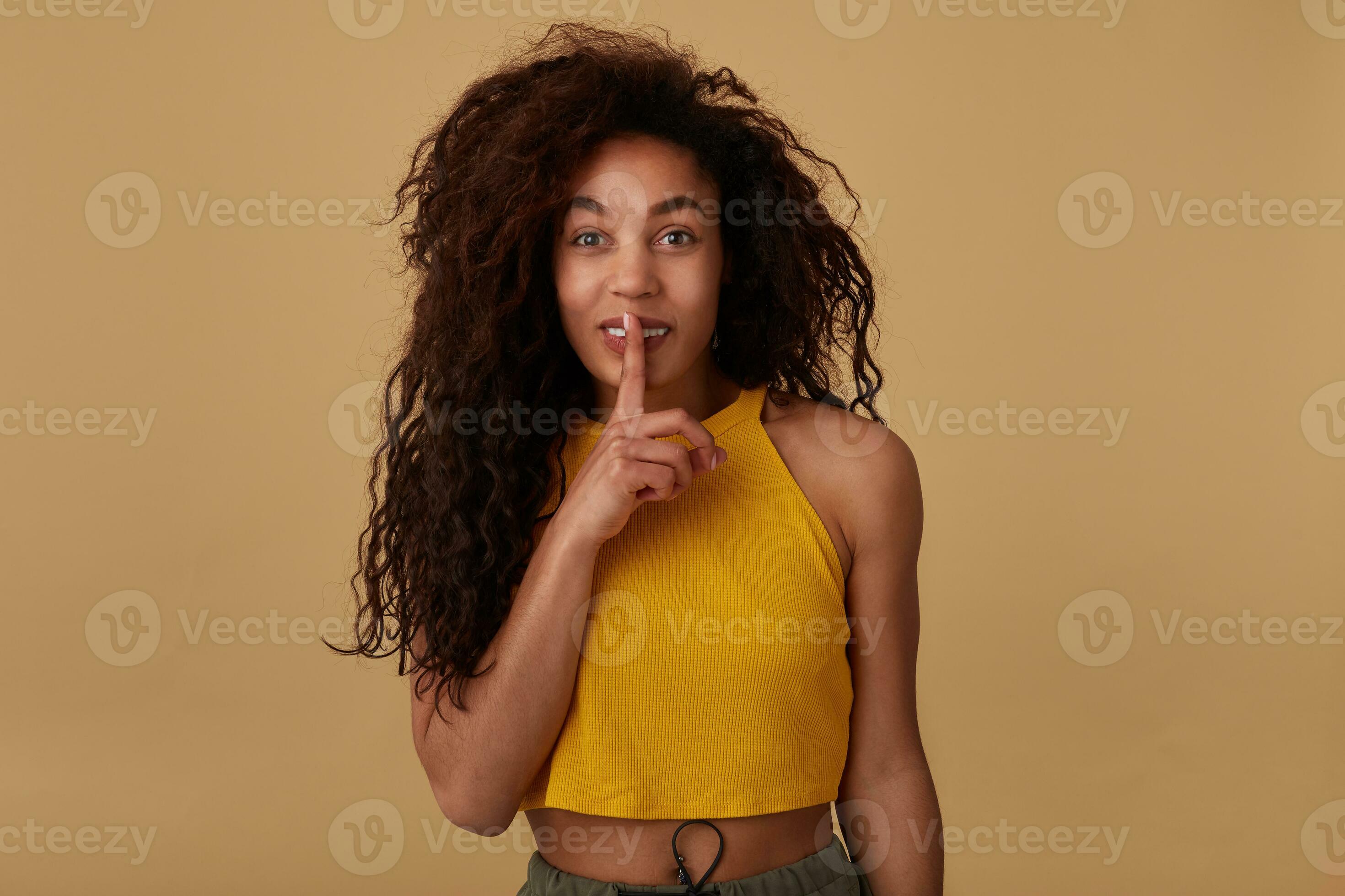 Positive Young Pretty Long Haired Curly Dark Skinned Female With