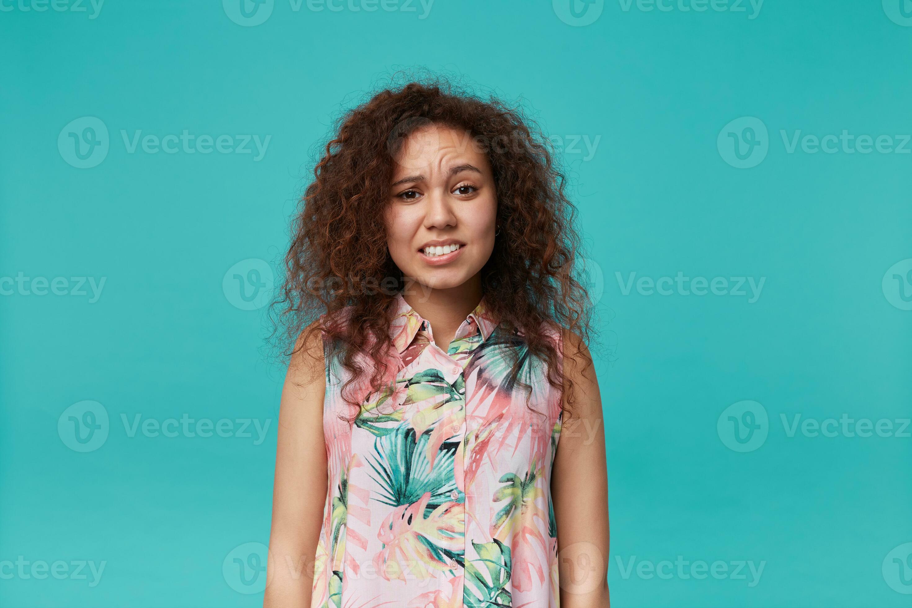 Bewildered Young Lovely Brown Eyed Curly Brunette Female Grimacing Her