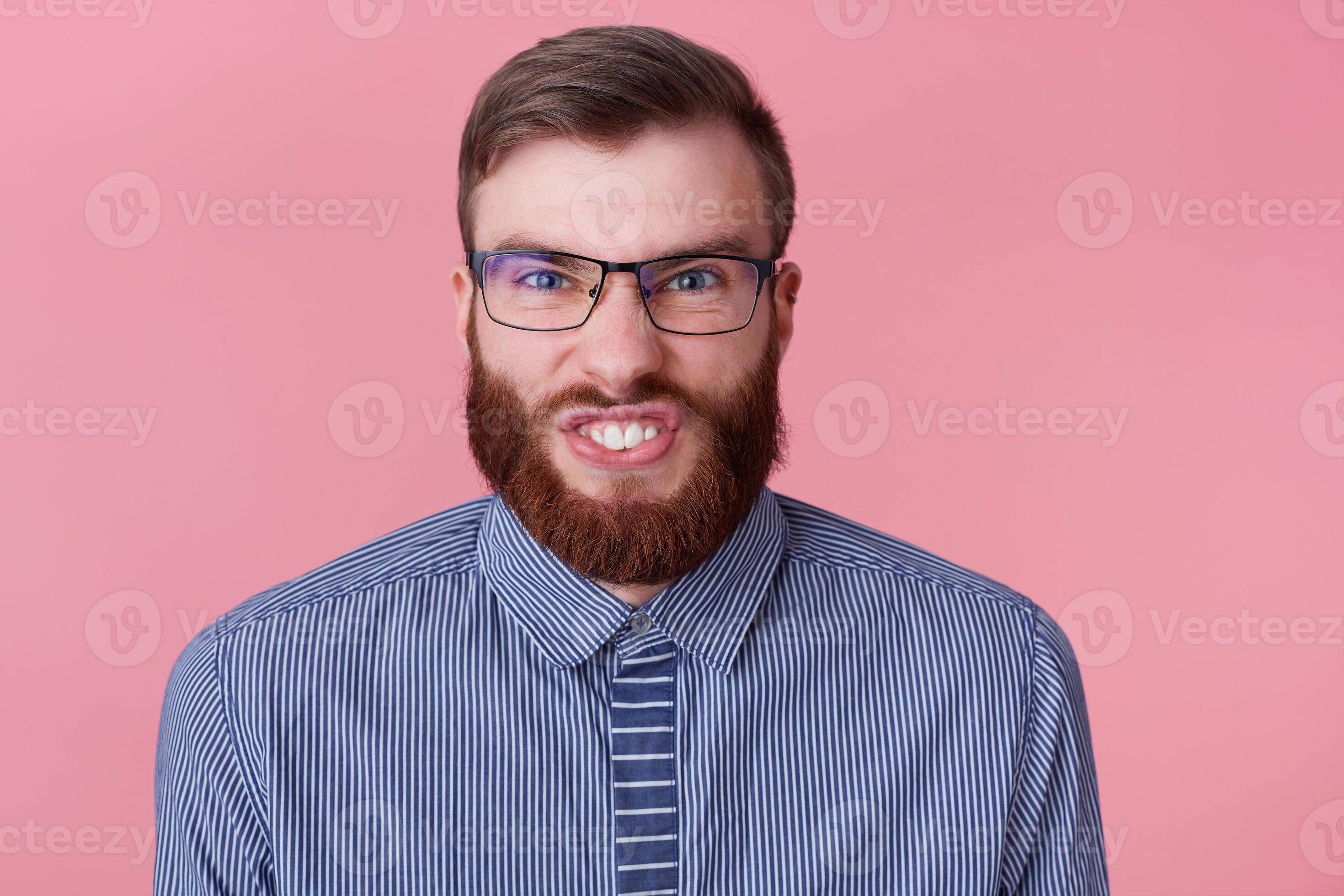 Close up of displeased angry young handsome red bearded man with ...