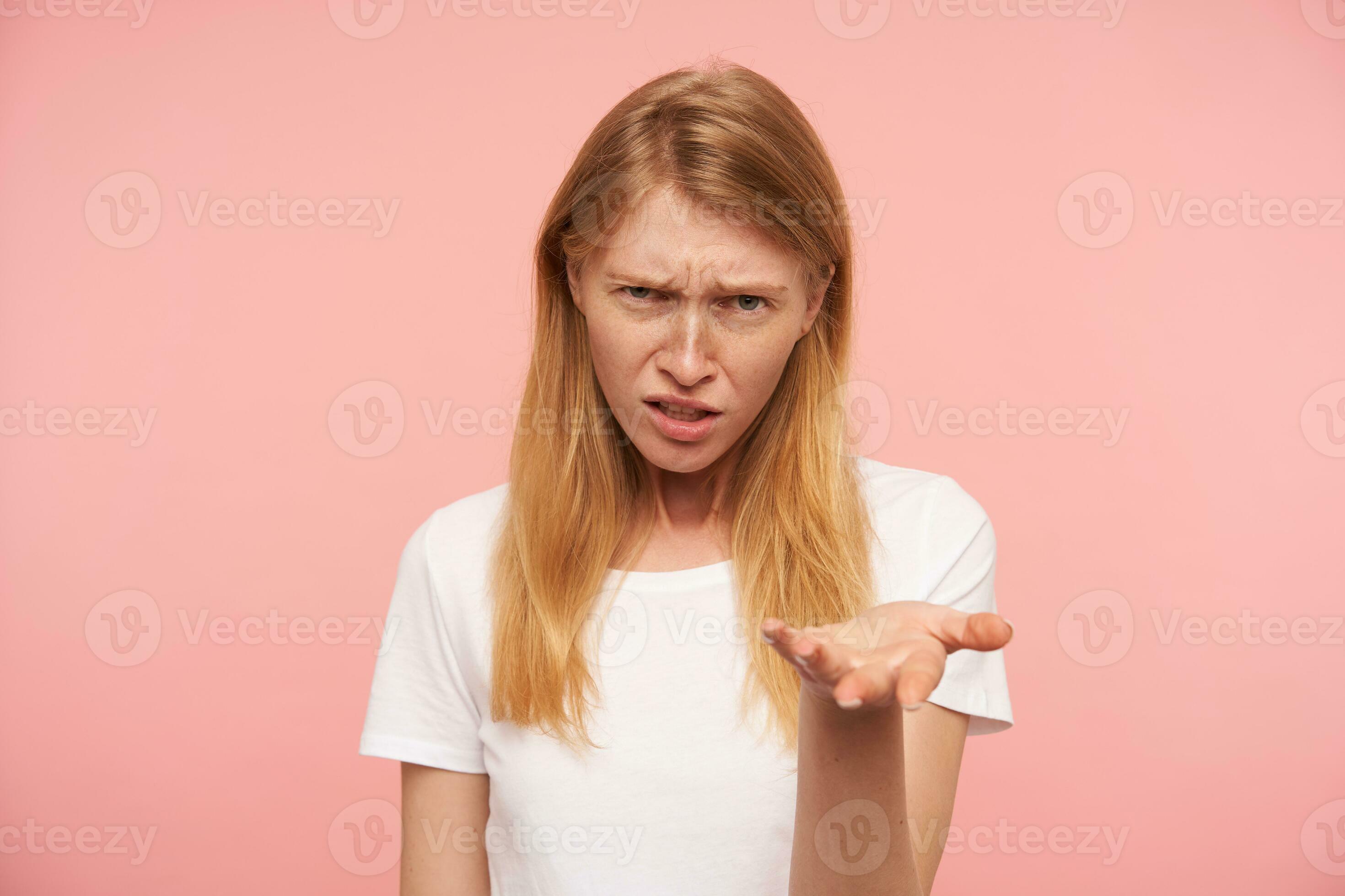 Displeased Young Attractive Long Haired Redhead Woman Keeping Her Hand