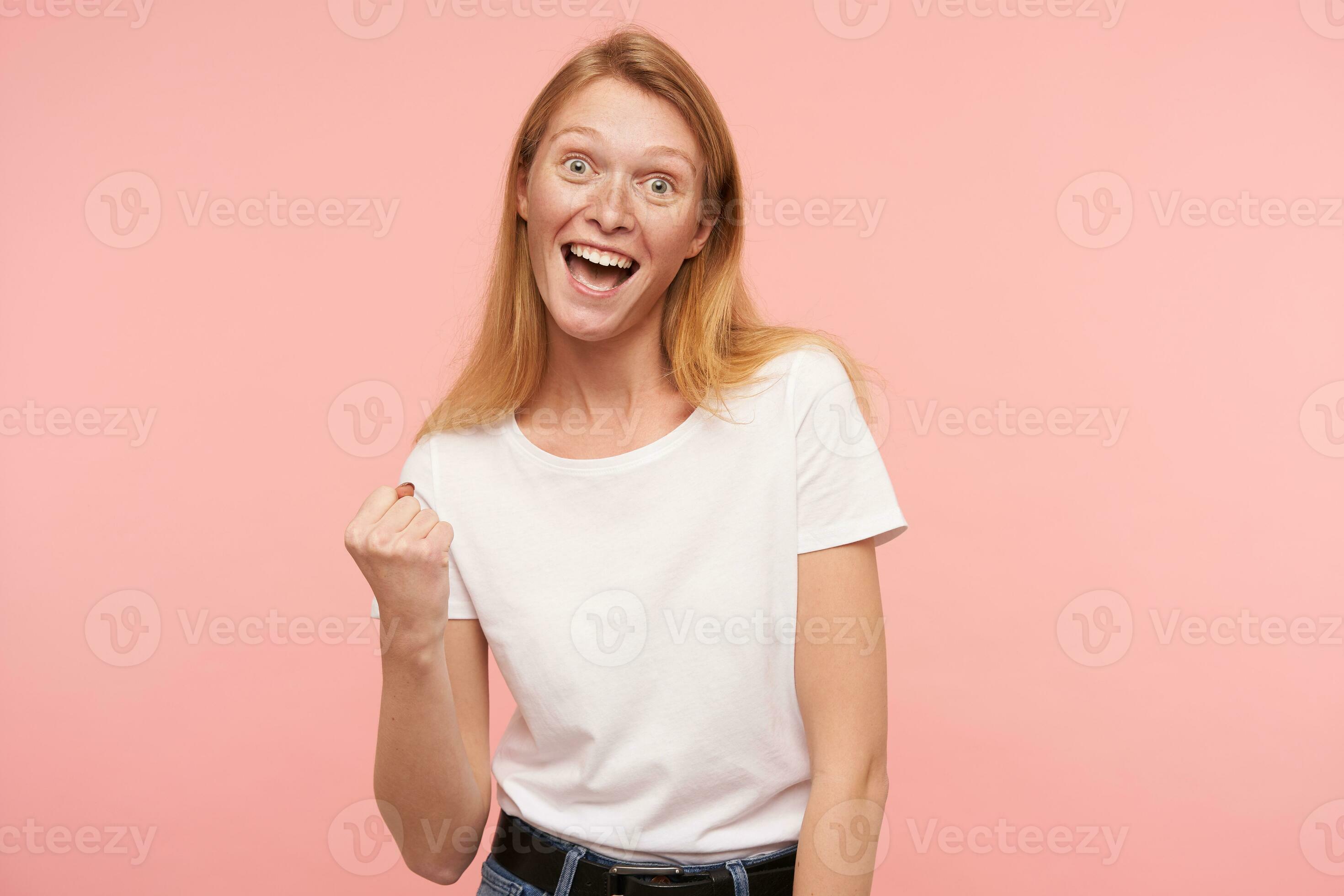 Overjoyed Young Attractive Long Haired Redhead Female Raising Excitedly
