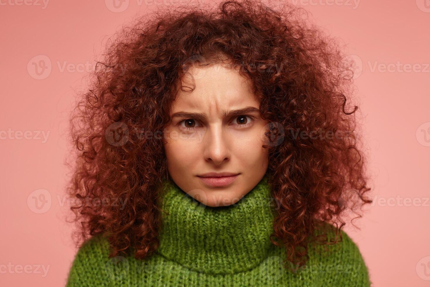 Portrait of attractive, adult girl with ginger curly hair. Unsatisfied ...