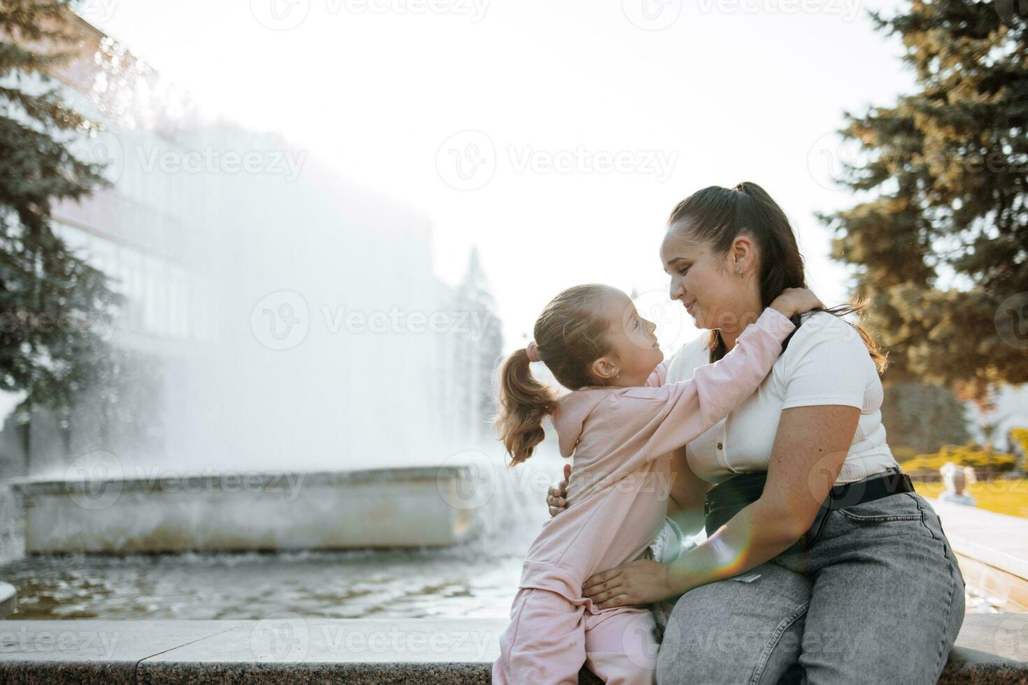 Close up side view overjoyed smiling young mother and daughter hugging ...