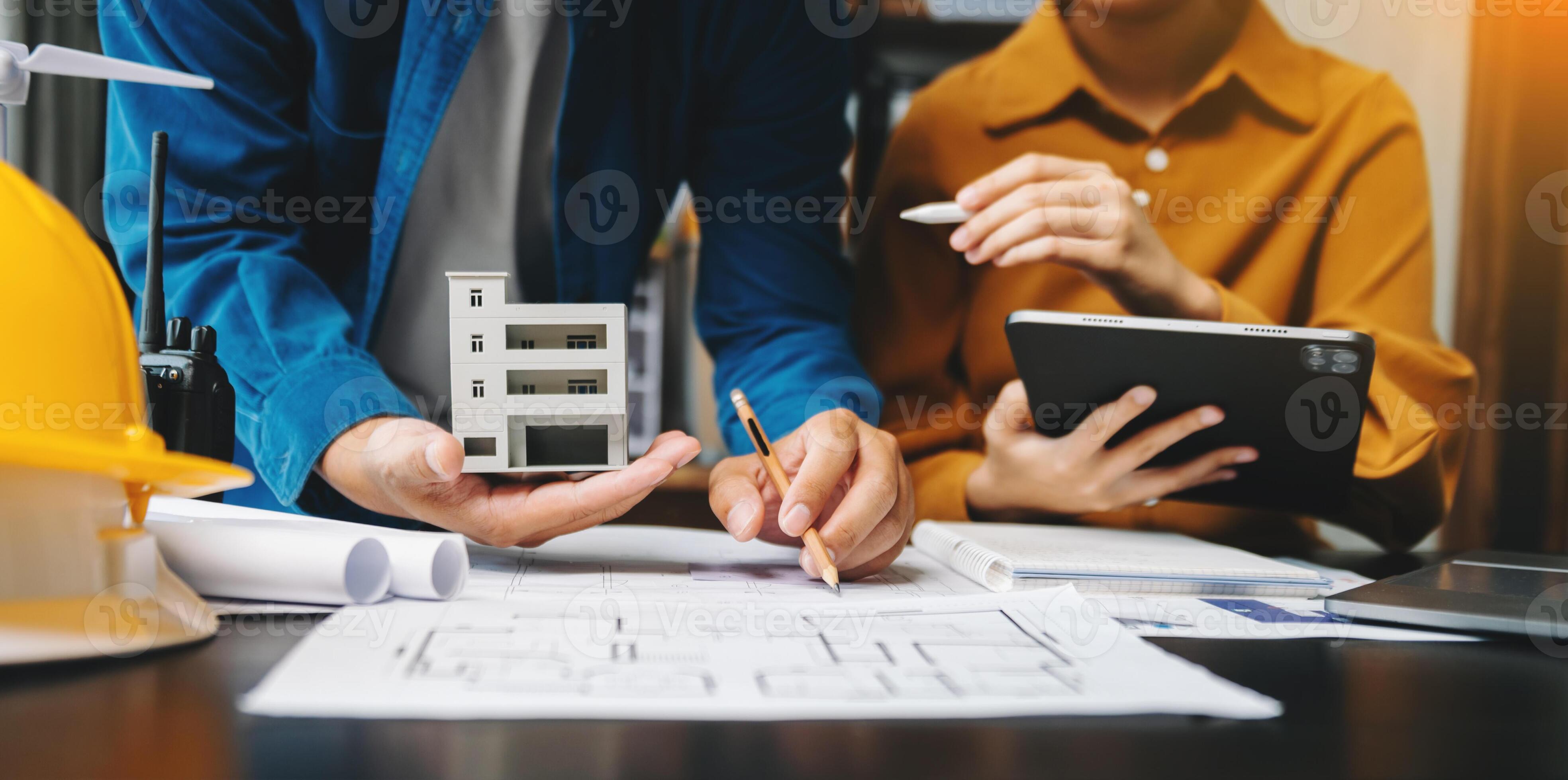 Engineer teams meeting working together wear worker helmets hardhat on construction site in ...