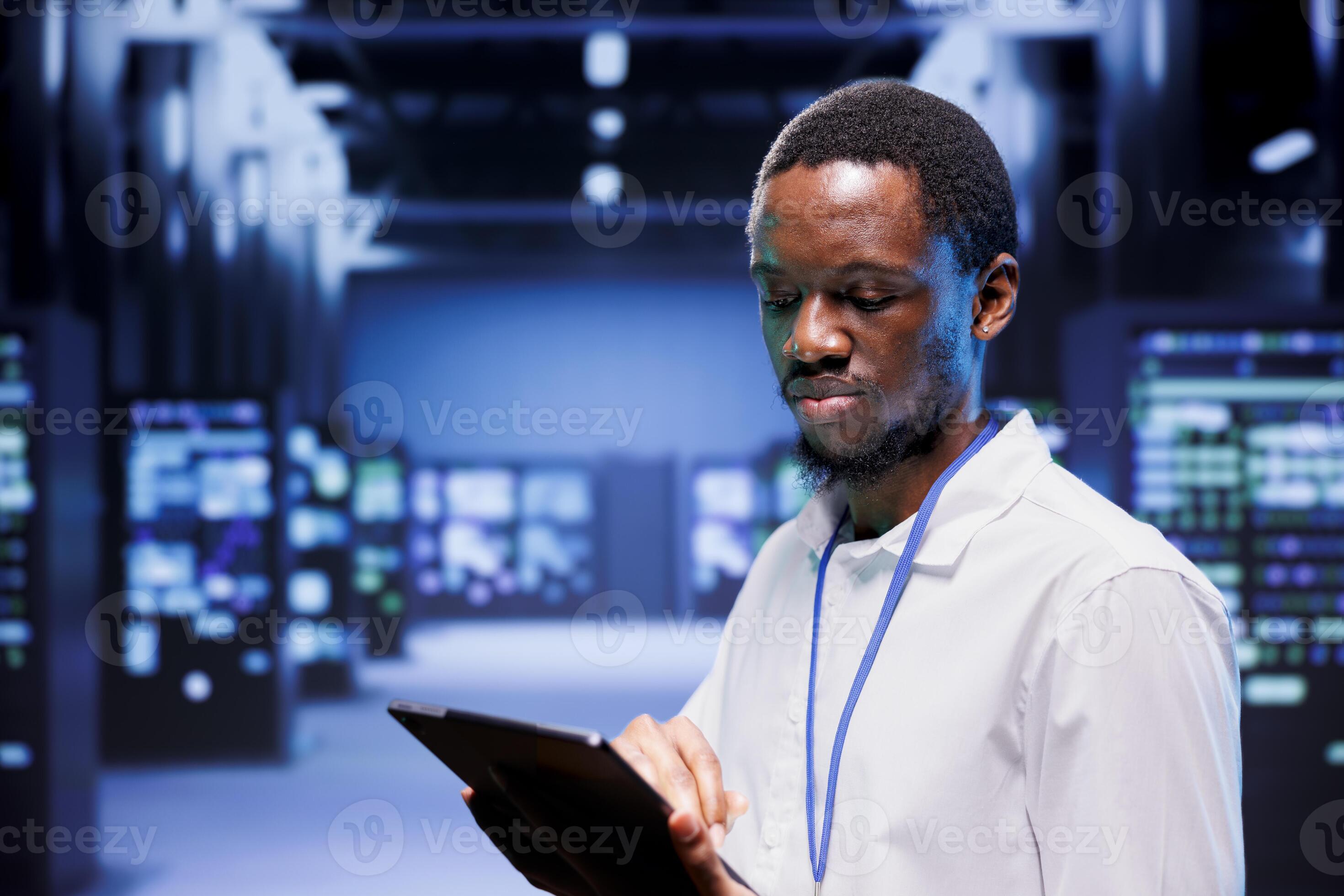 IT specialist in server farm ensuring valuable data remains shielded from potential threats ...