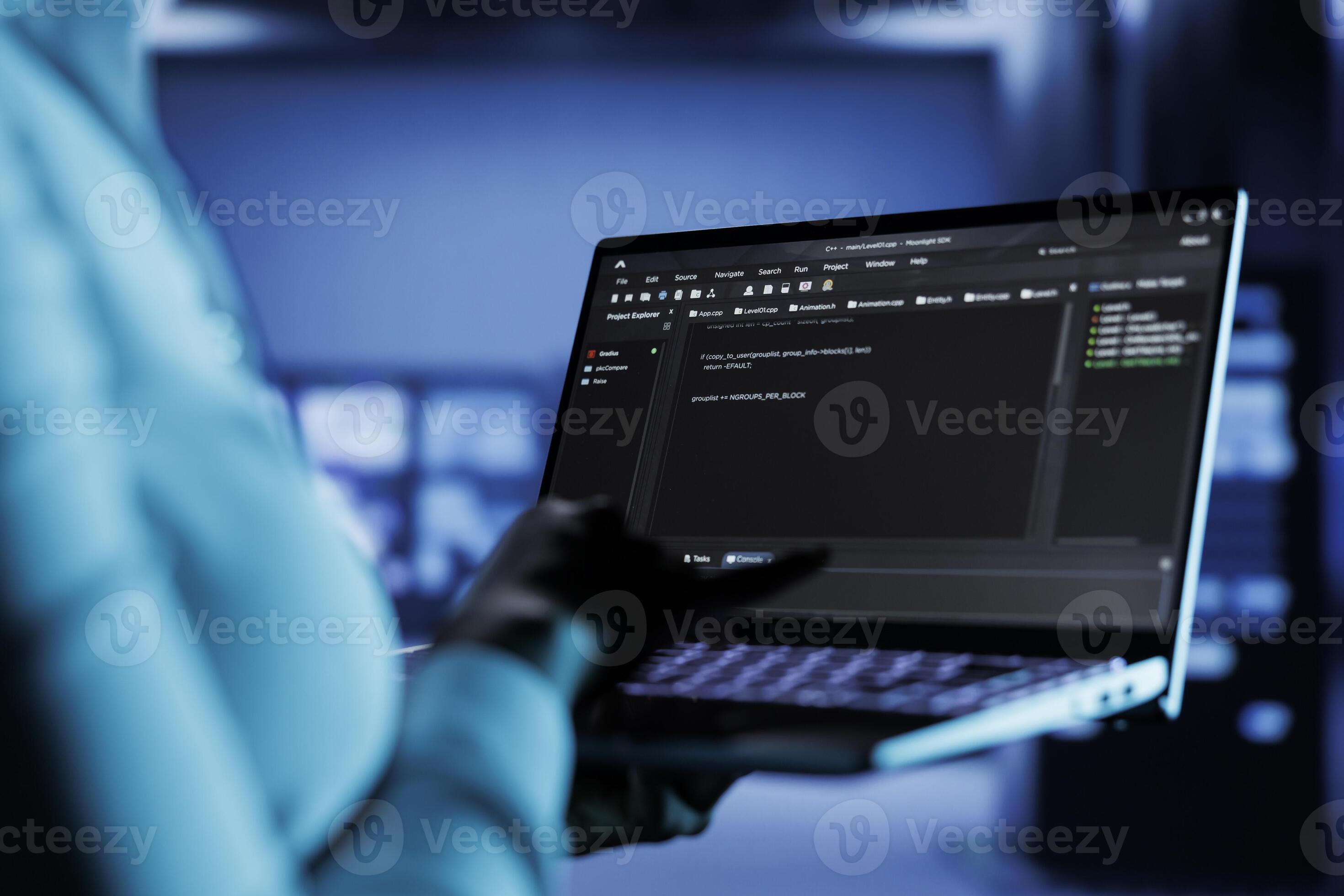 Qualified engineer running code and programming on laptop, troubleshooting and upgrading high ...