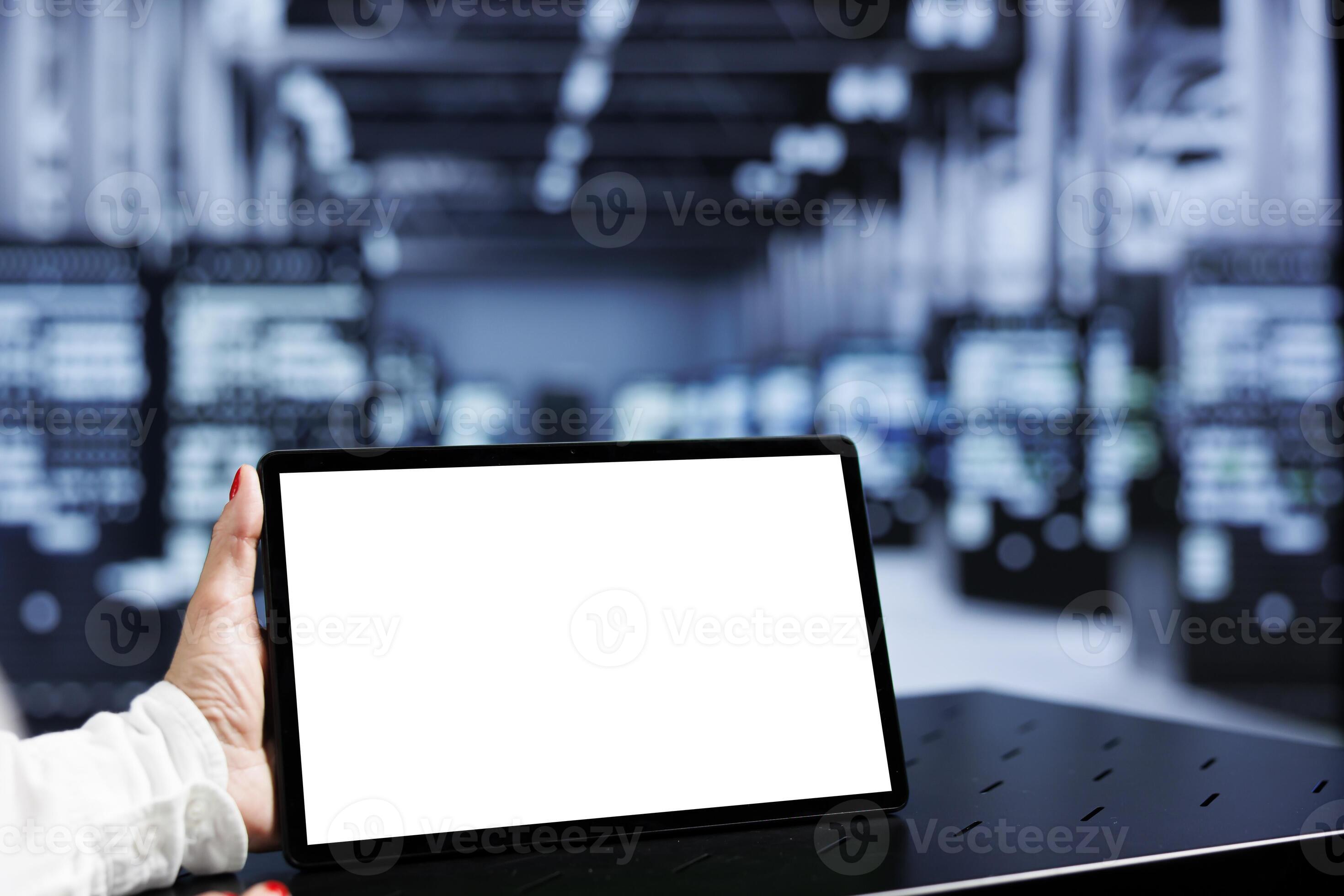 Close up shot of mock up tablet used by technician in server hub delivering immense computing ...