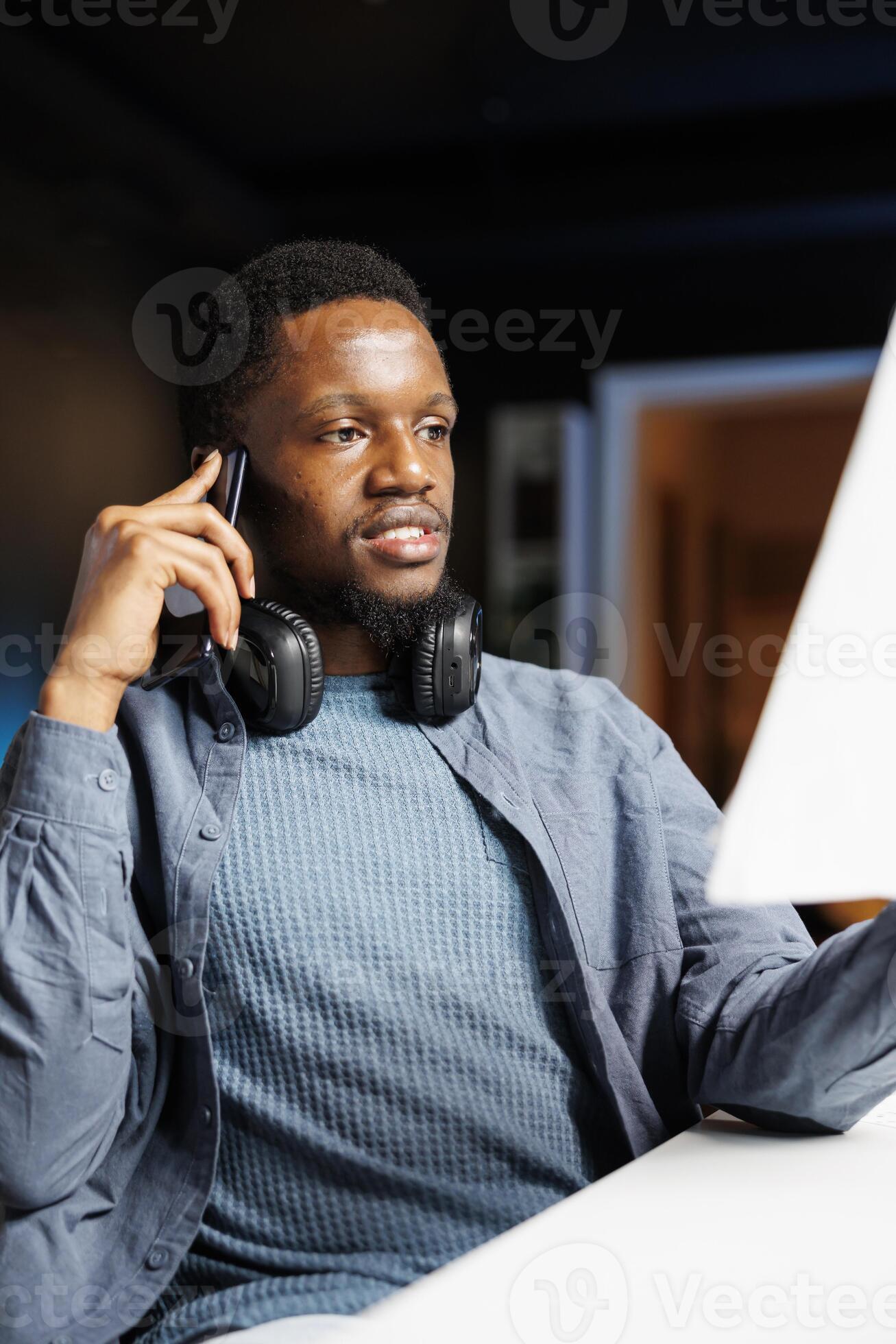 At home, investment banker studies equity balance statement sheets while engaged in remote tasks ...