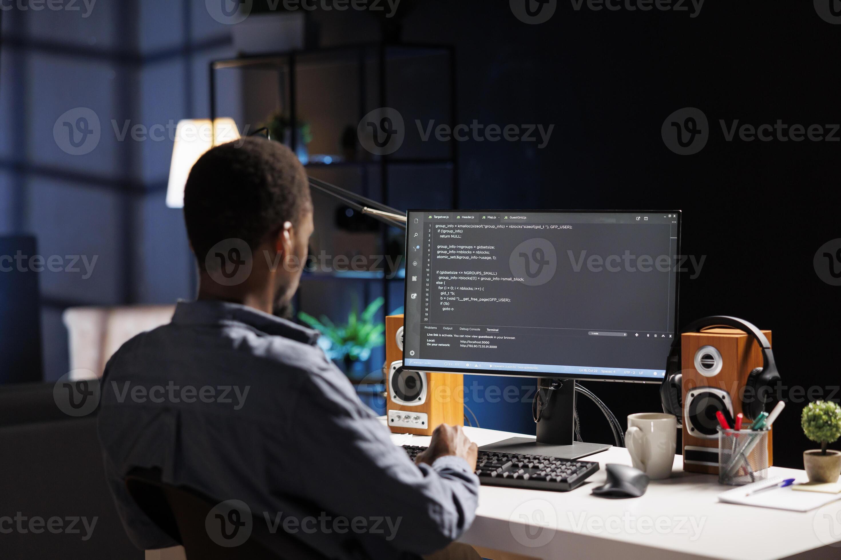 Male developer entering binary data on terminal panel while establishing html code. Software ...