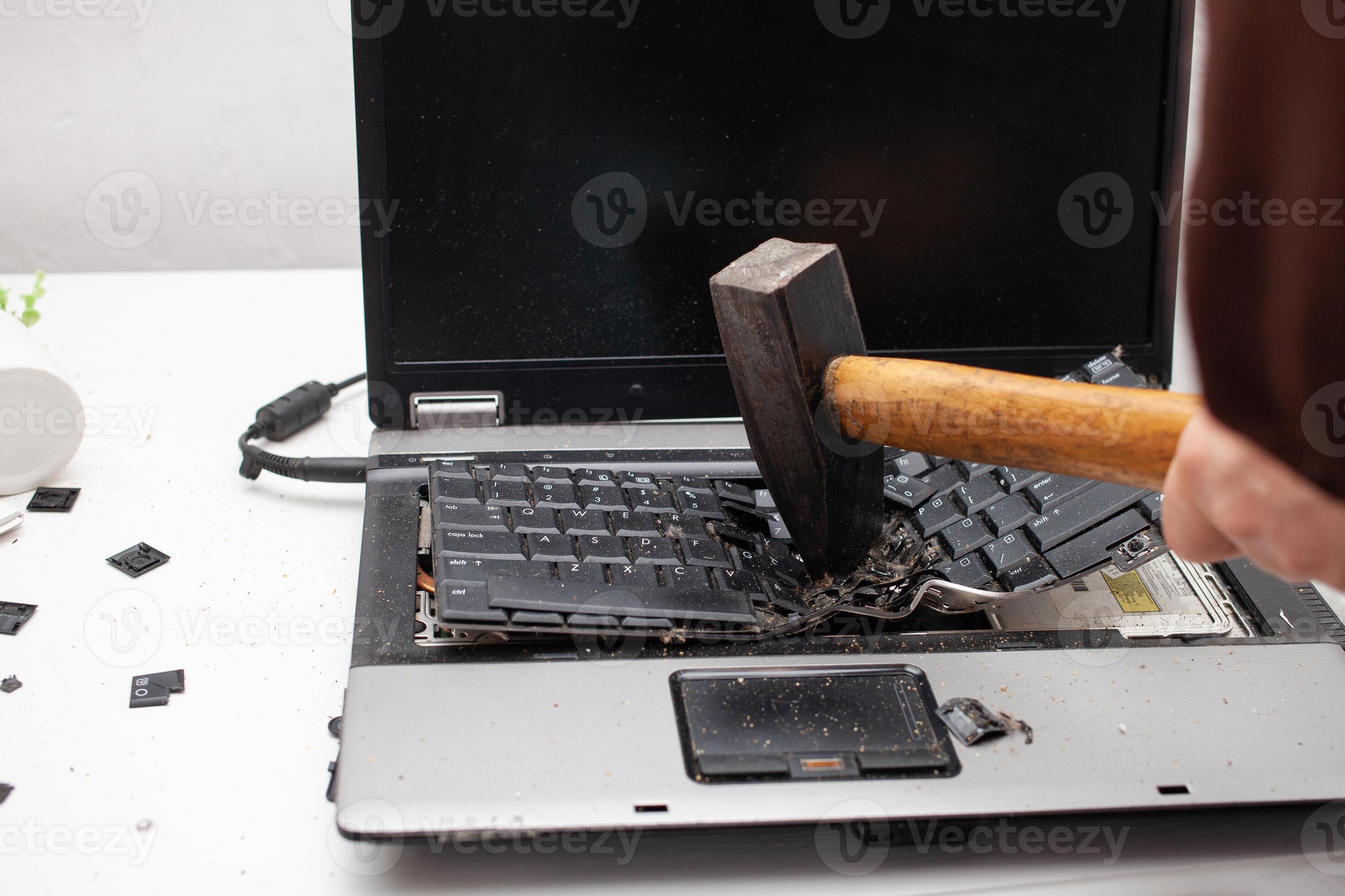 man office worker smashed a laptop, destroyed a computer. Anger, hatred ...