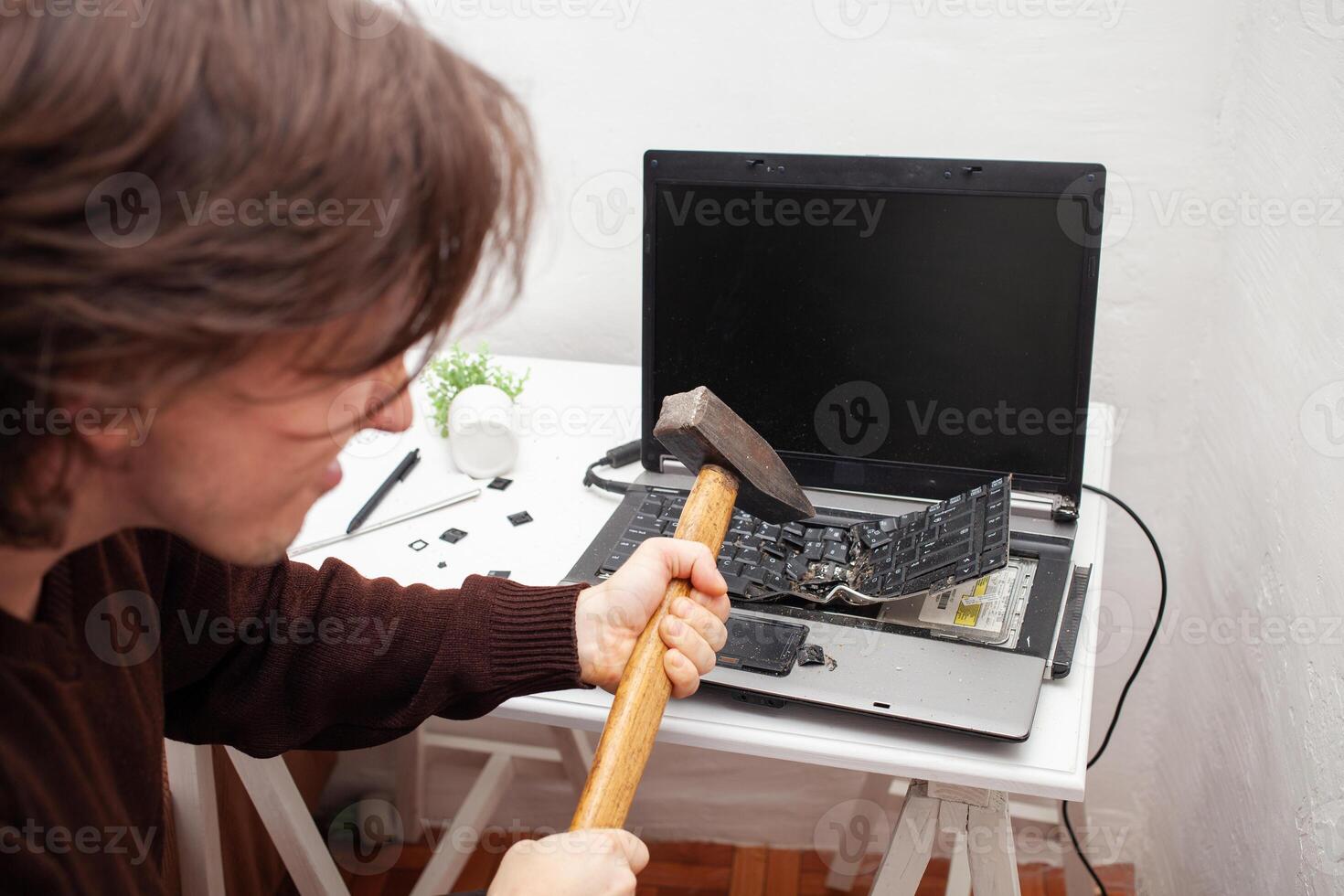 man office worker smashed a laptop, destroyed a computer. Anger, hatred ...