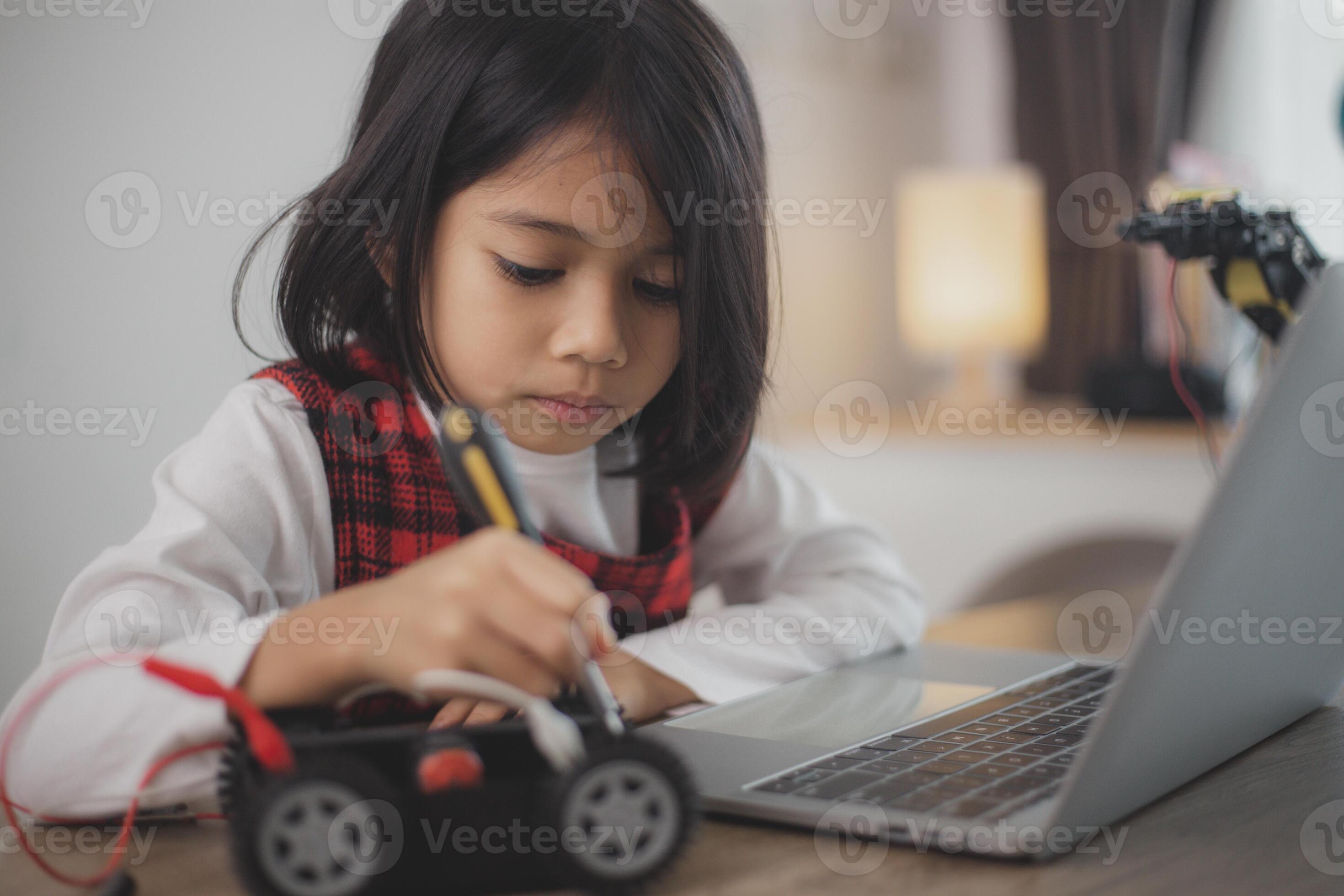 STEM education concept. Asian students learn at home by coding robot ...