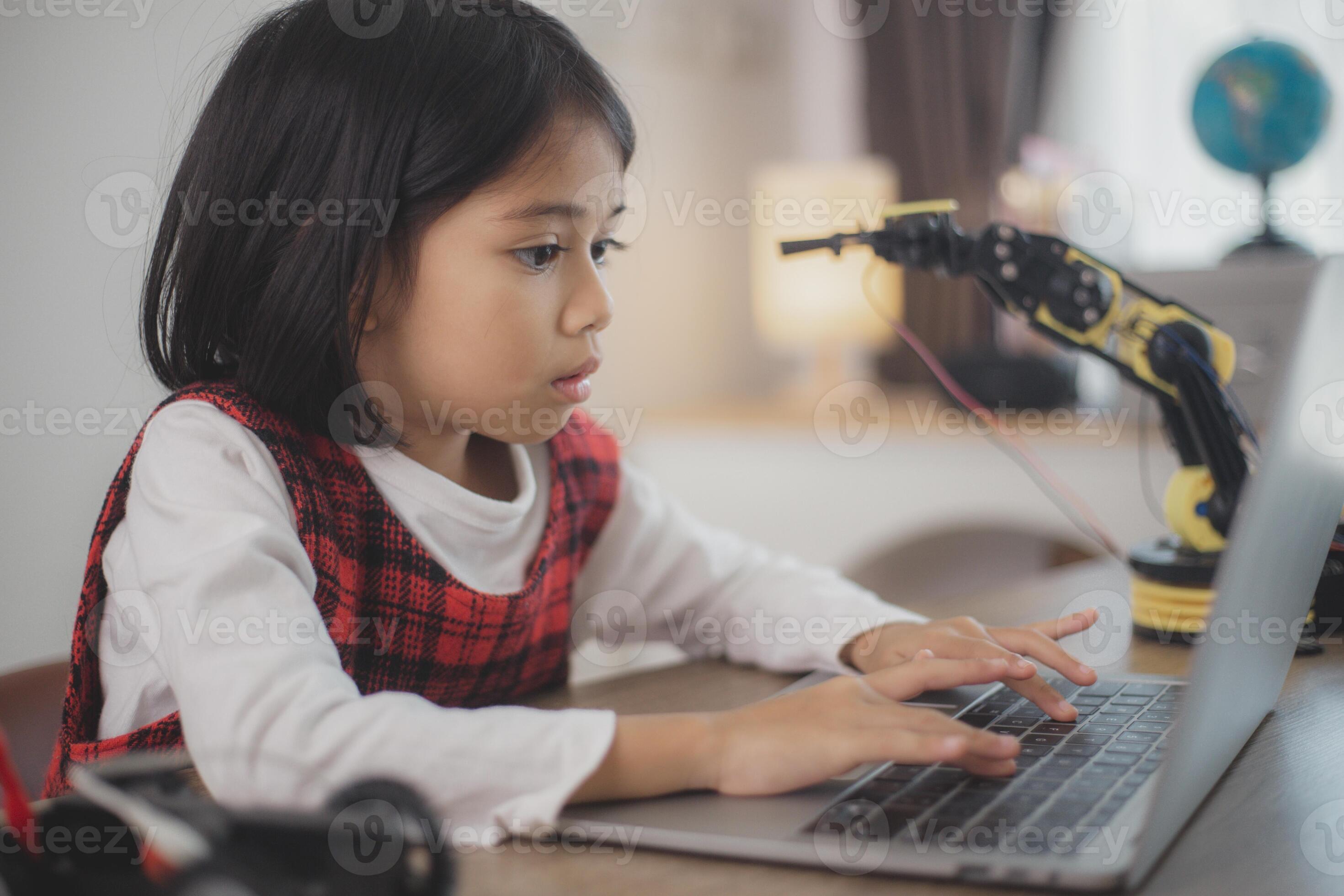 STEM education concept. Asian students learn at home by coding robot arms in STEM, mathematics ...